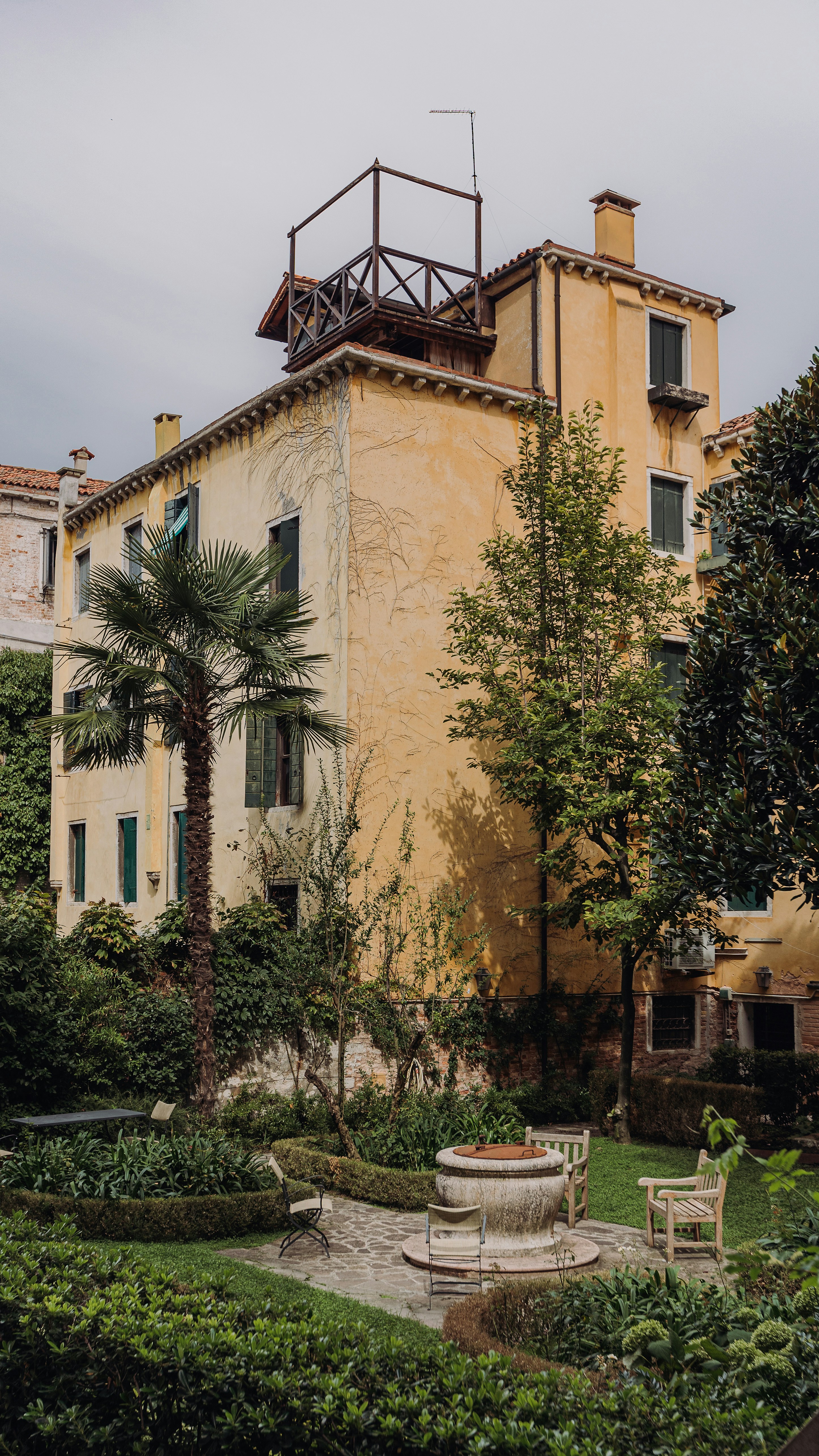 Yellow building with a garden in venice.