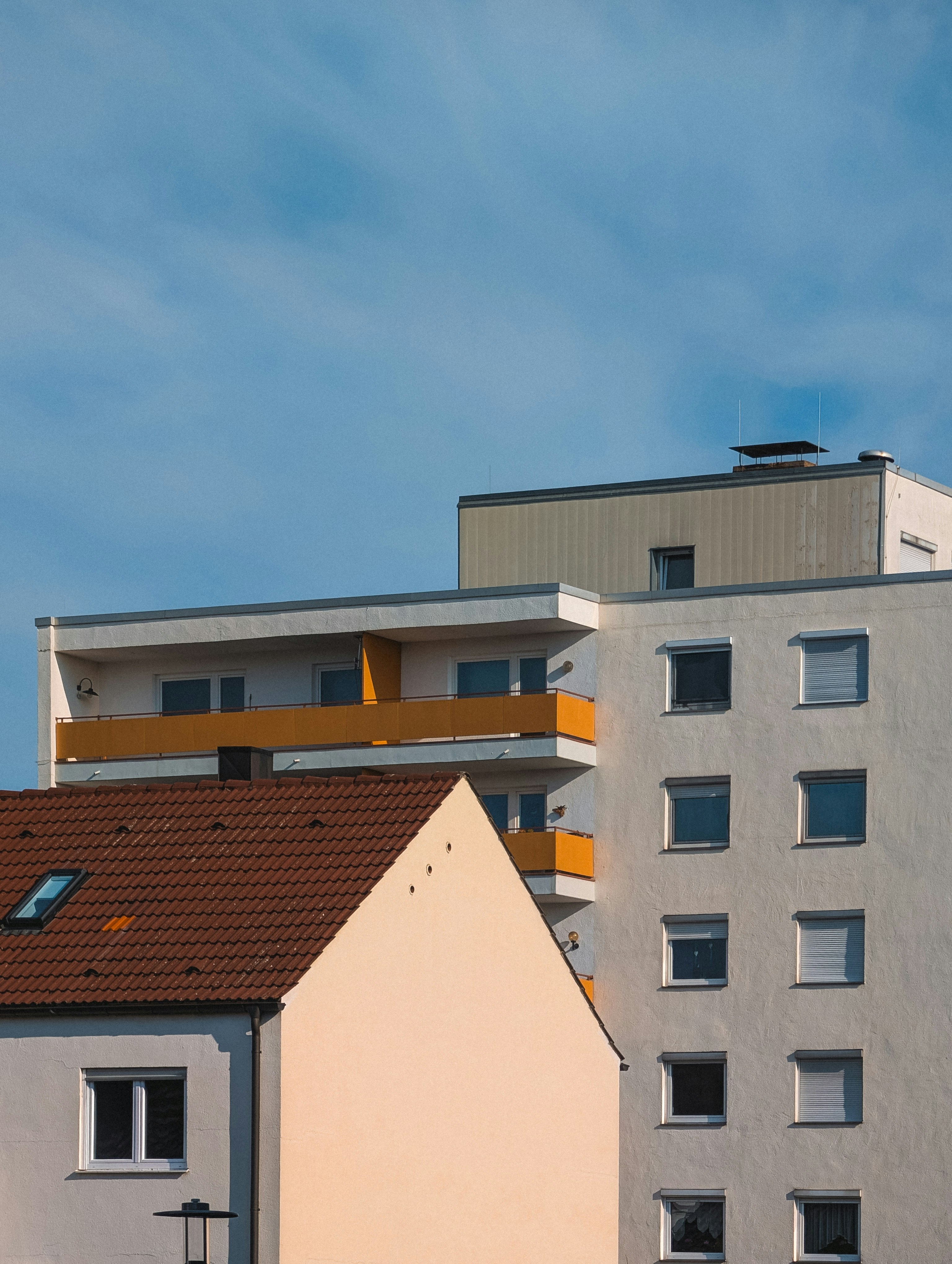 Residential Blocks with Balconies | Buildings against a clear blue sky are displayed.