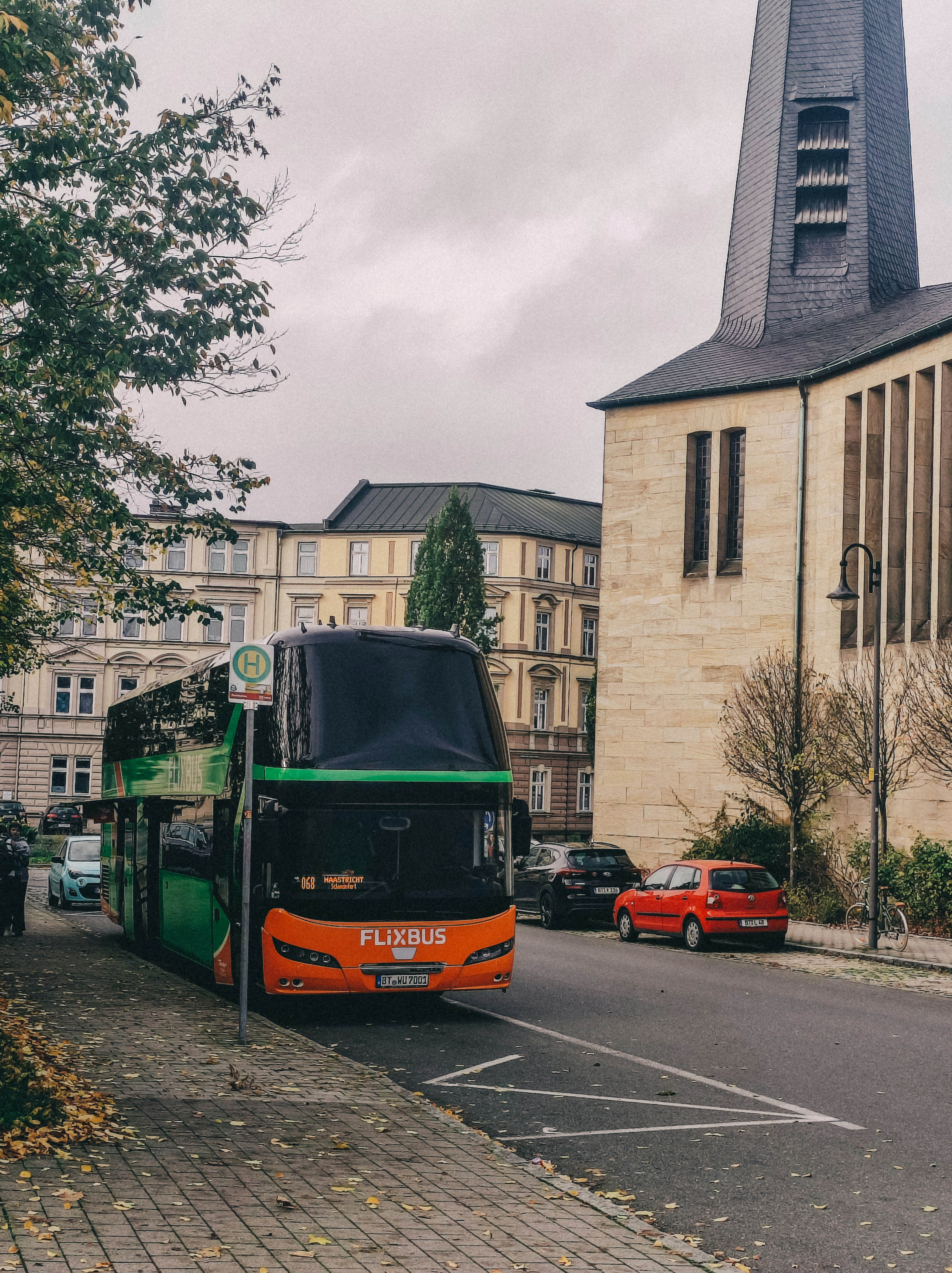 FlixBus at Church Stop | A double-decker flixbus is parked on a street.