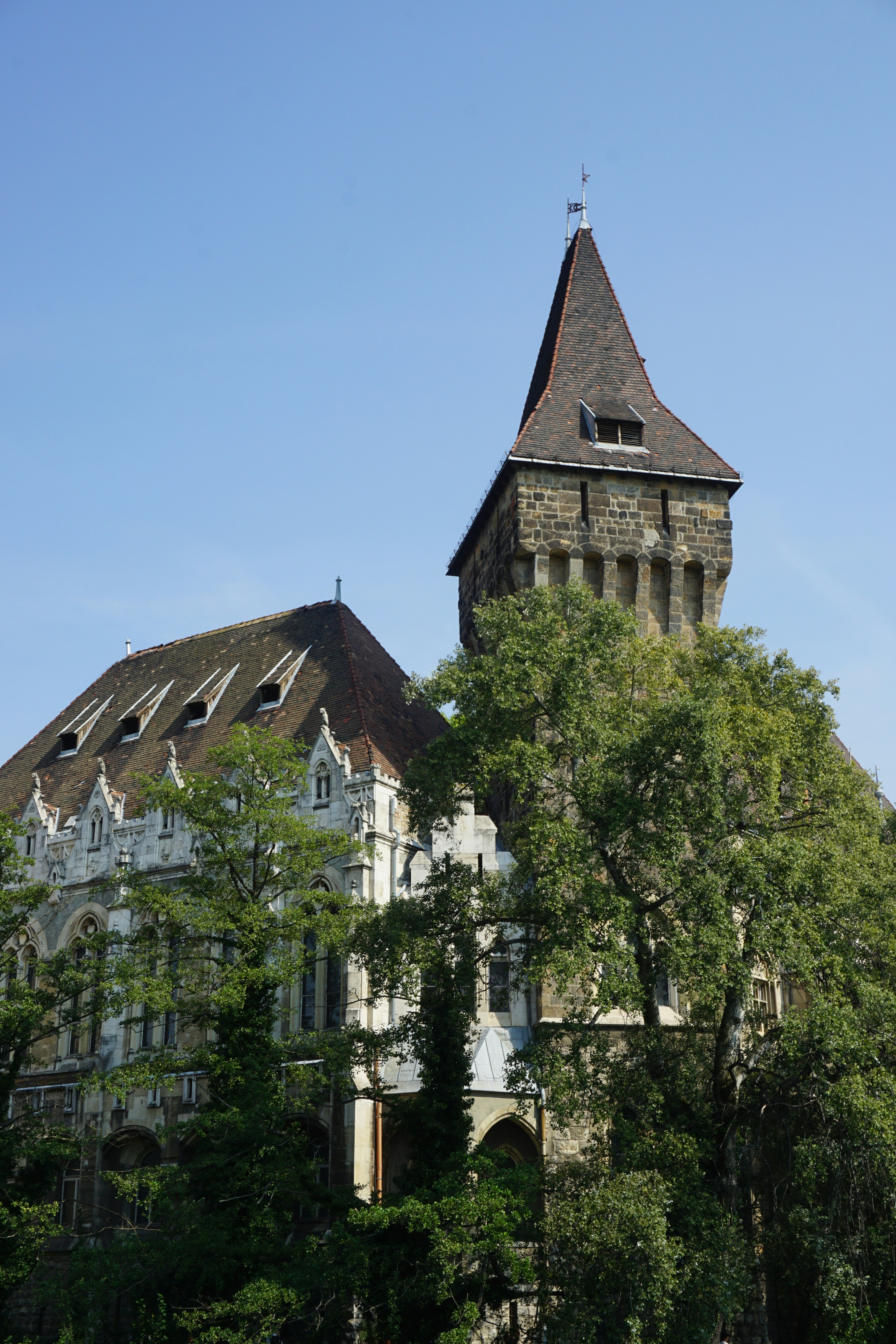 A beautiful castle rises against a clear blue sky.