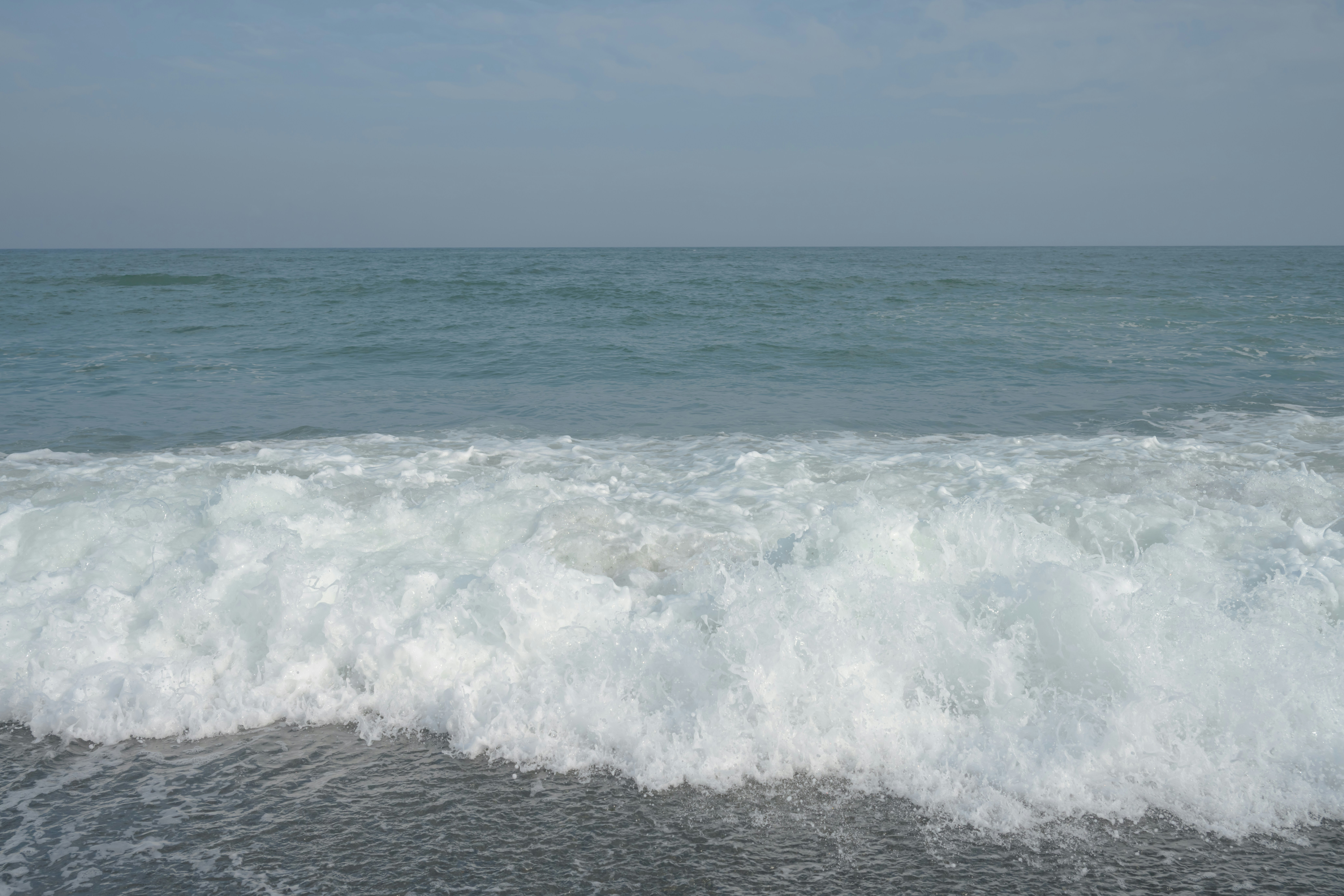 Waves crash on the shoreline.