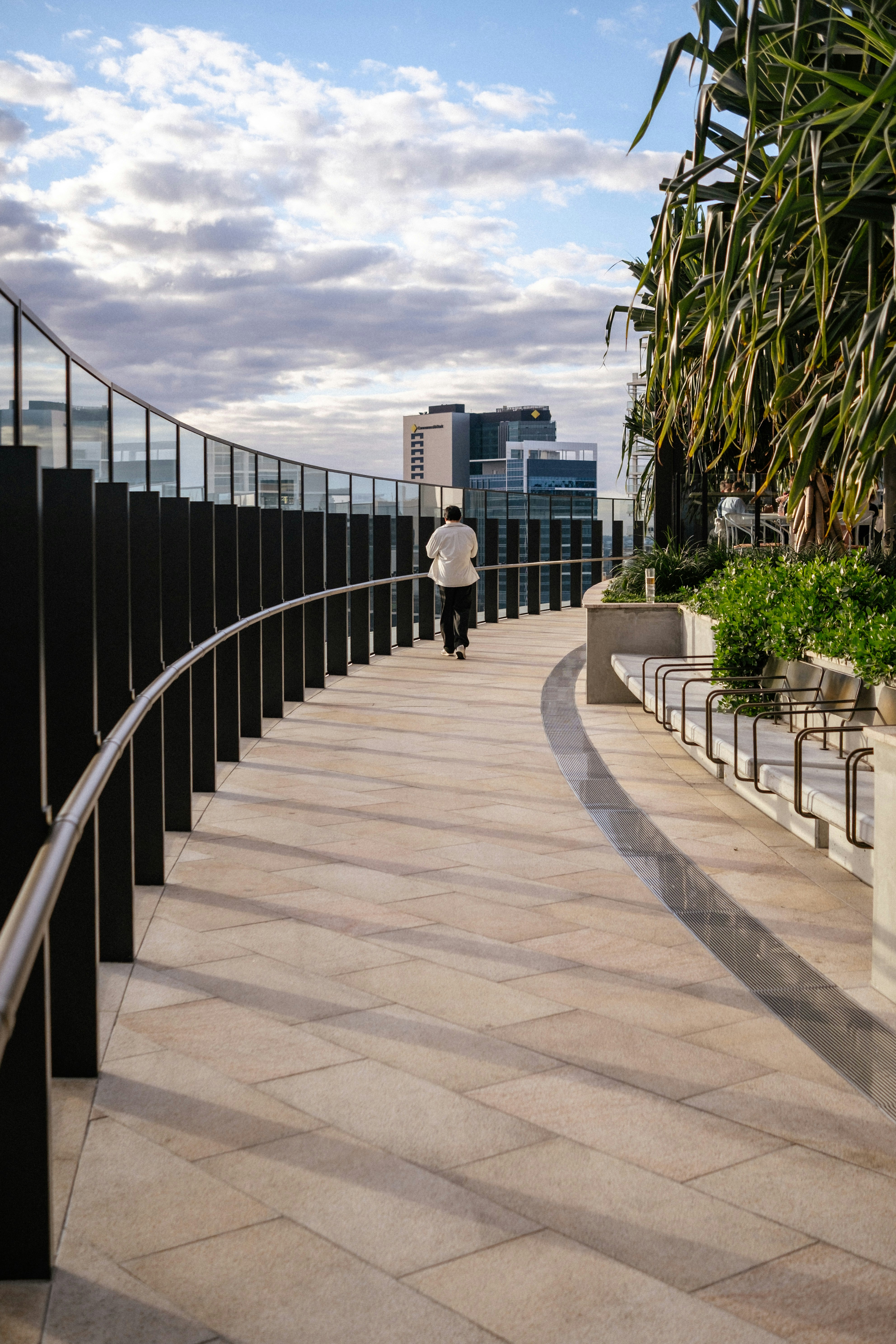 A person walks along a rooftop path.