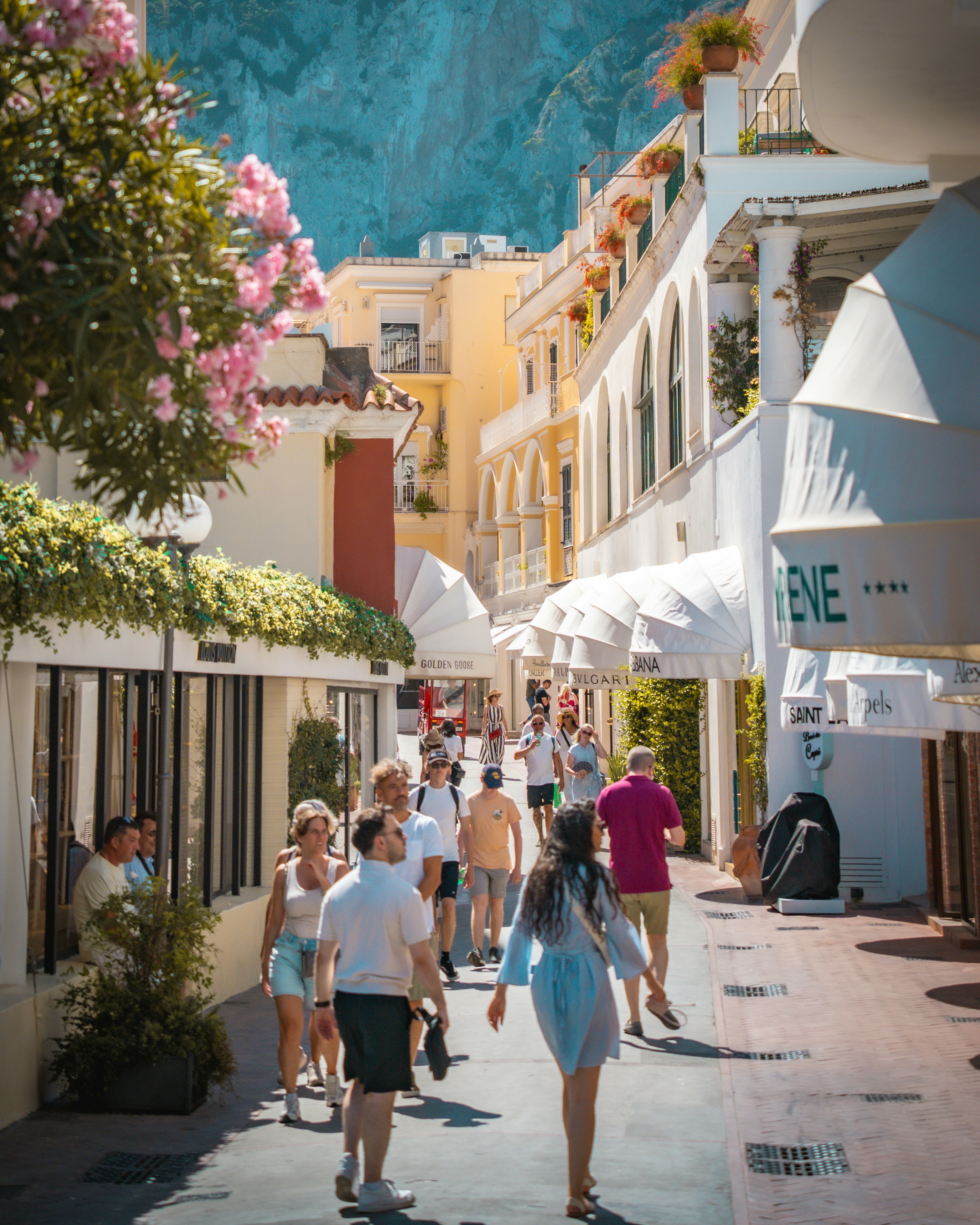 Sunlit Mediterranean Street Breathing with People and Shops