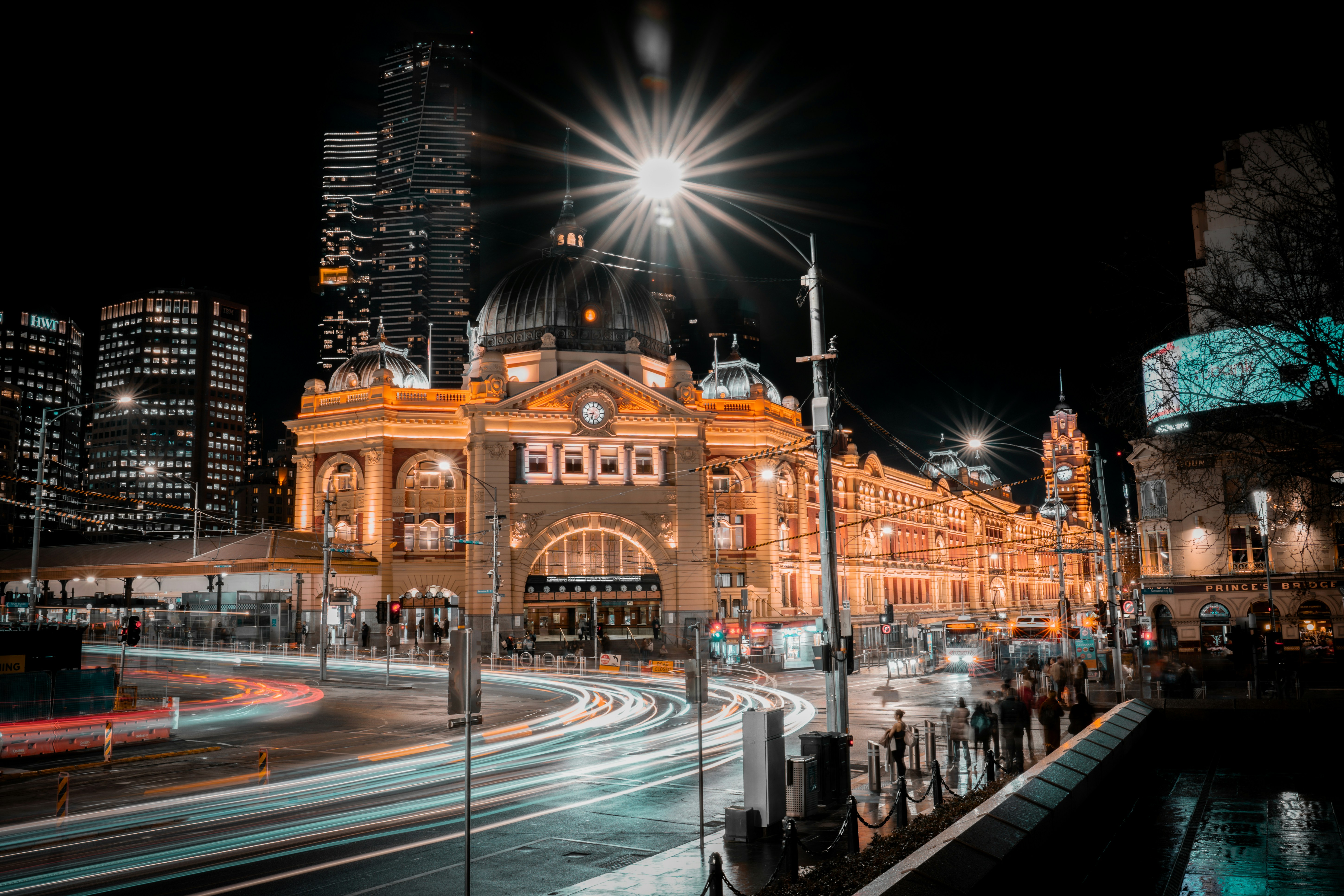 View of Flinder Station in Melbourne at night. | Nighttime view of a lit up building in a city.