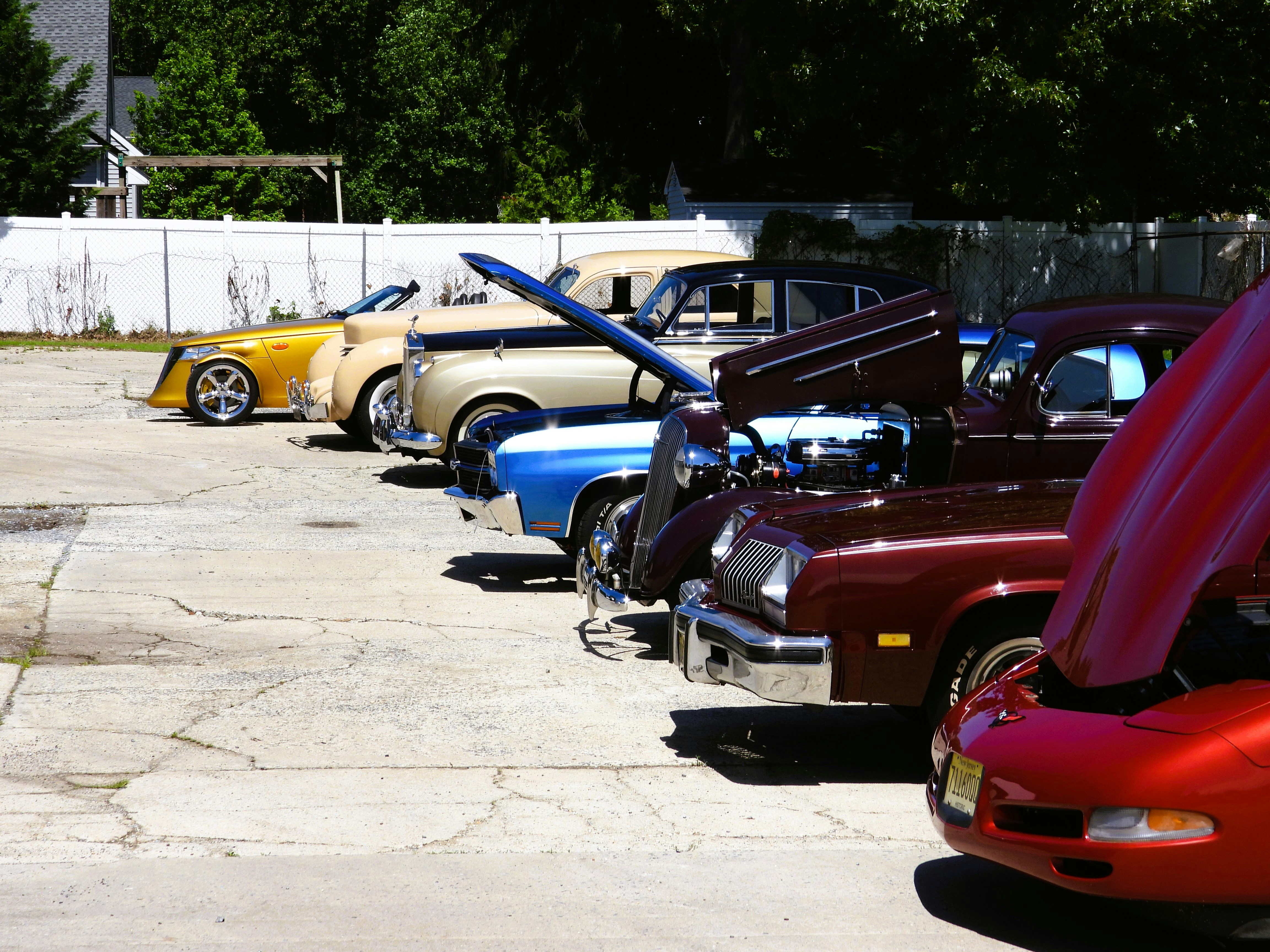 Chrome Heritage: A Row of Classic Cars with Hood Props