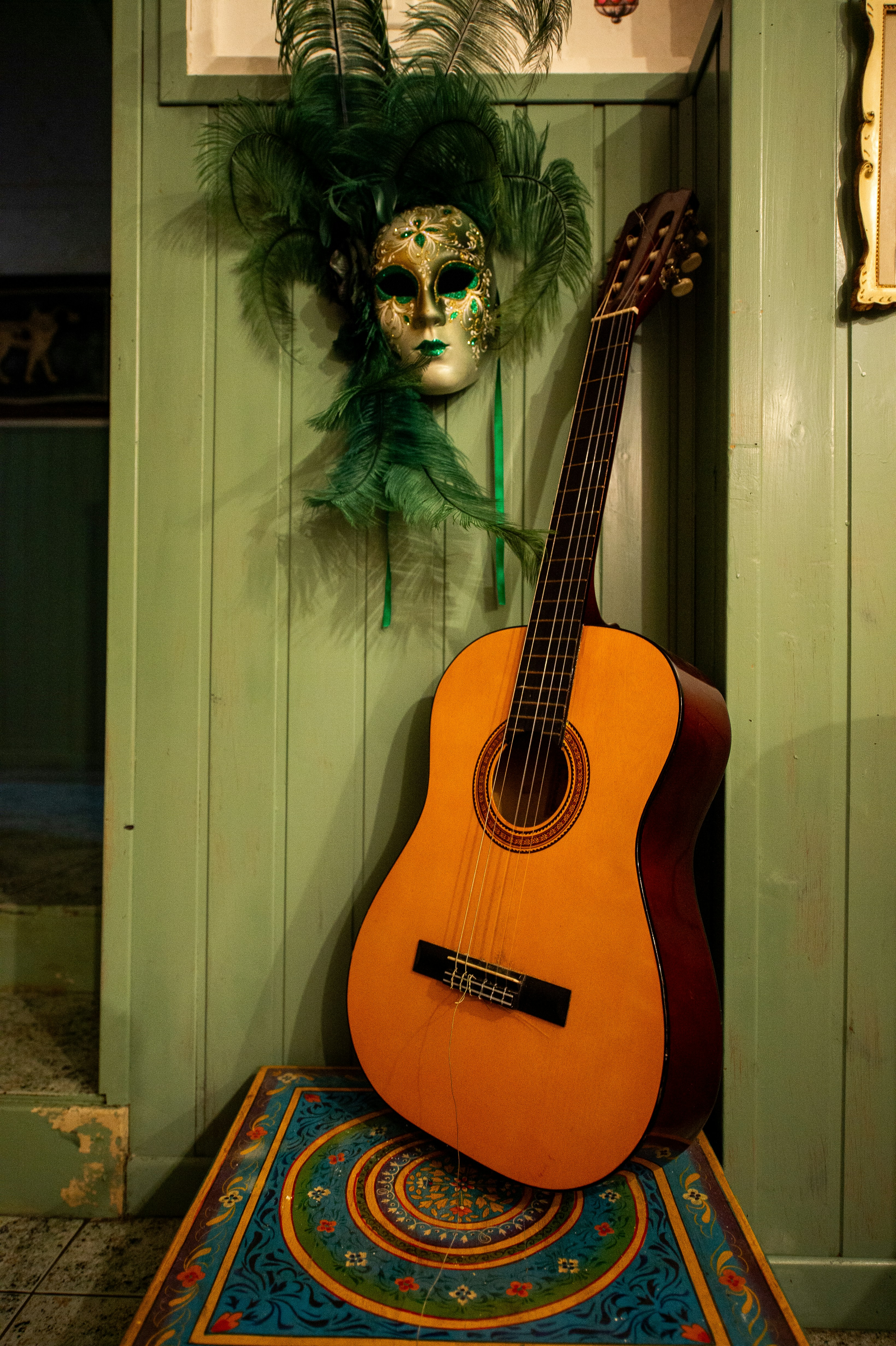 AS MAIN TITLE / PORTRAIT PROJECT - APortraitWithLu ❤️ | Guitar leans against green wall with a mask.