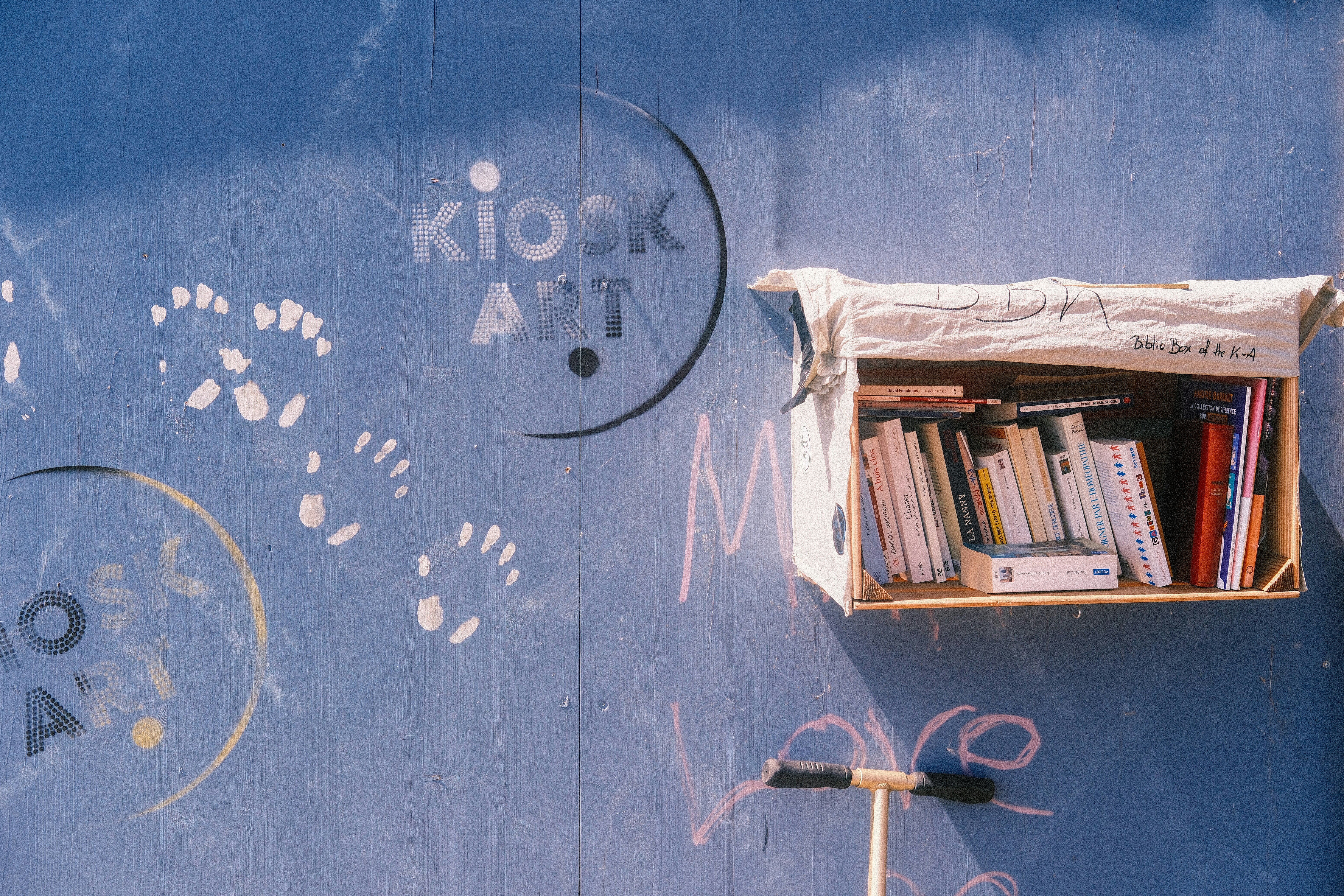 Blue Wall Gallery: A Wall-Mhelf with a Small Bookshelf and Chalked Graffiti