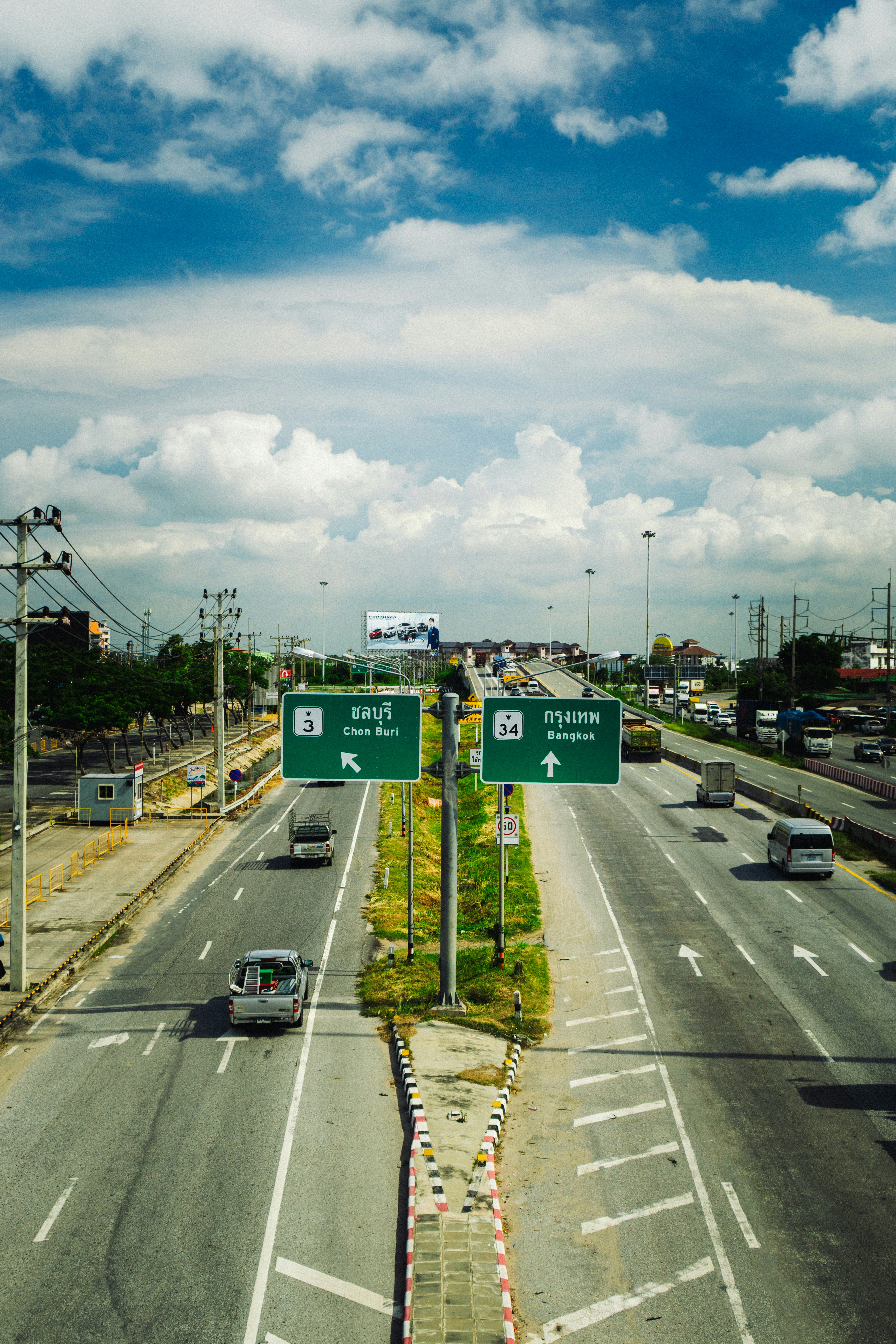 An elevated highway with signs and blue skies.