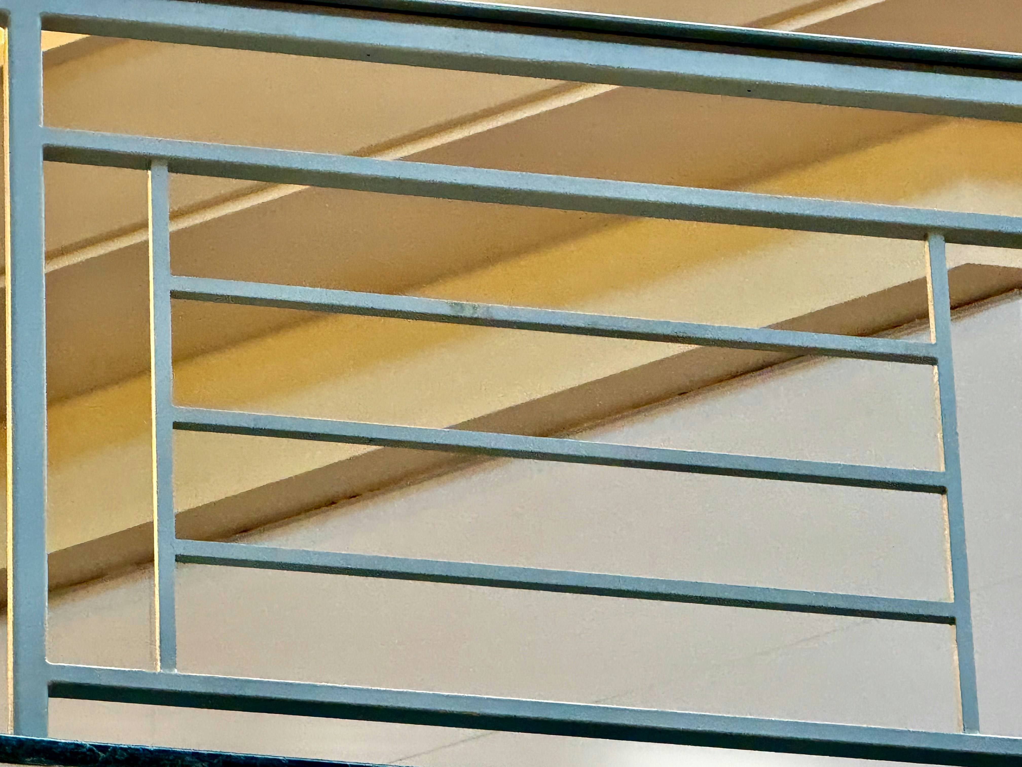 A metal railing with horizontal and vertical bars.