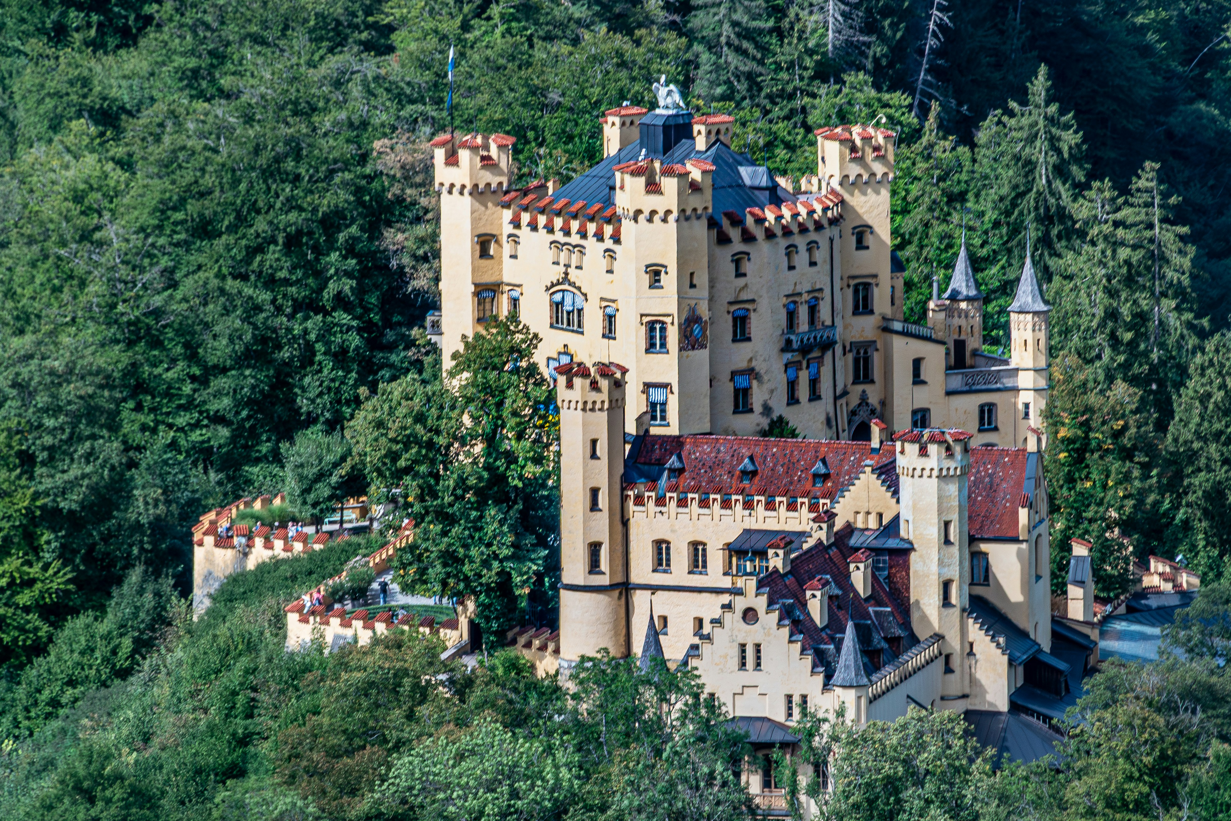 Hohenschwangau castle [Germany] | A majestic castle surrounded by lush greenery.
