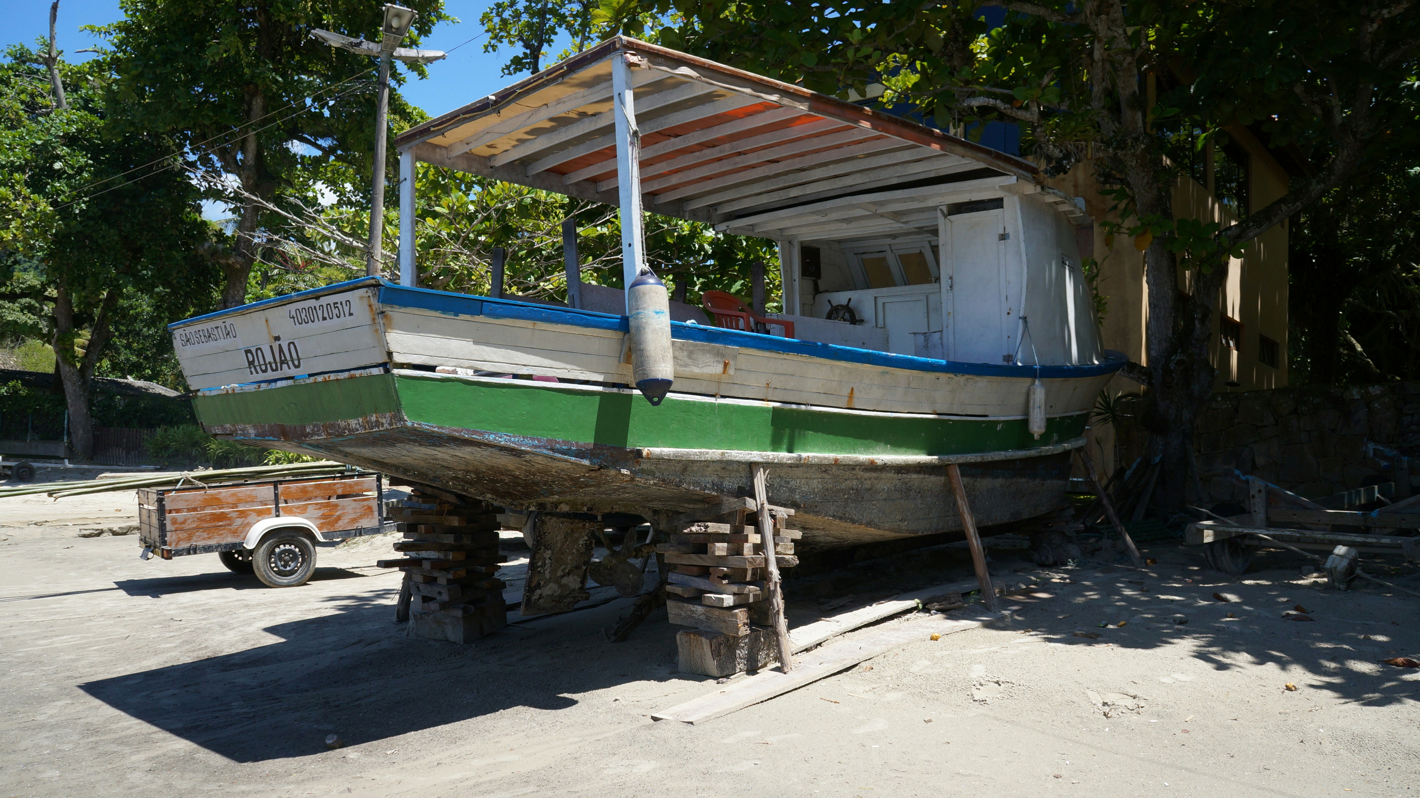 A boat rests on wooden supports.