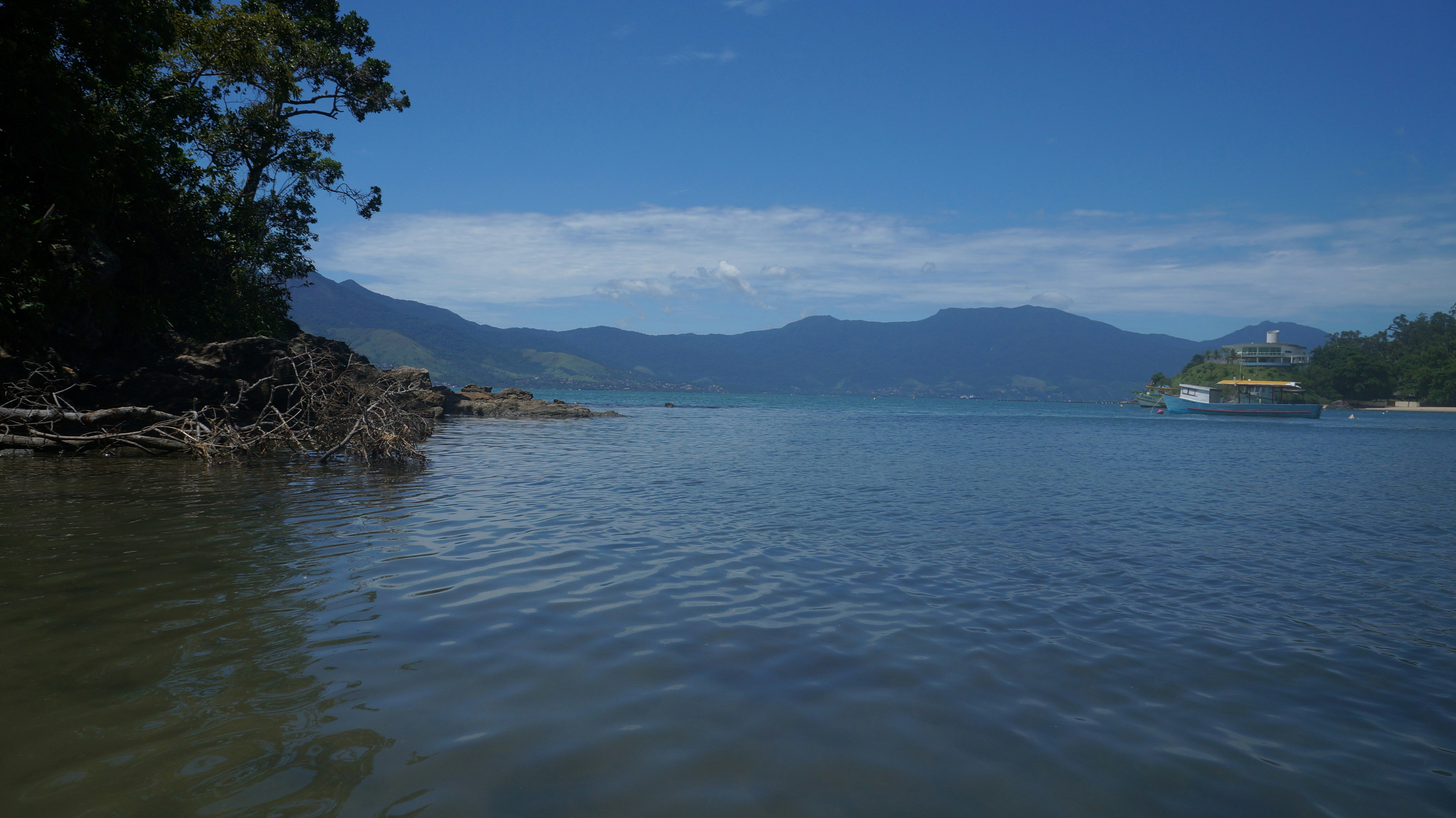 A calm ocean view under a bright blue sky.