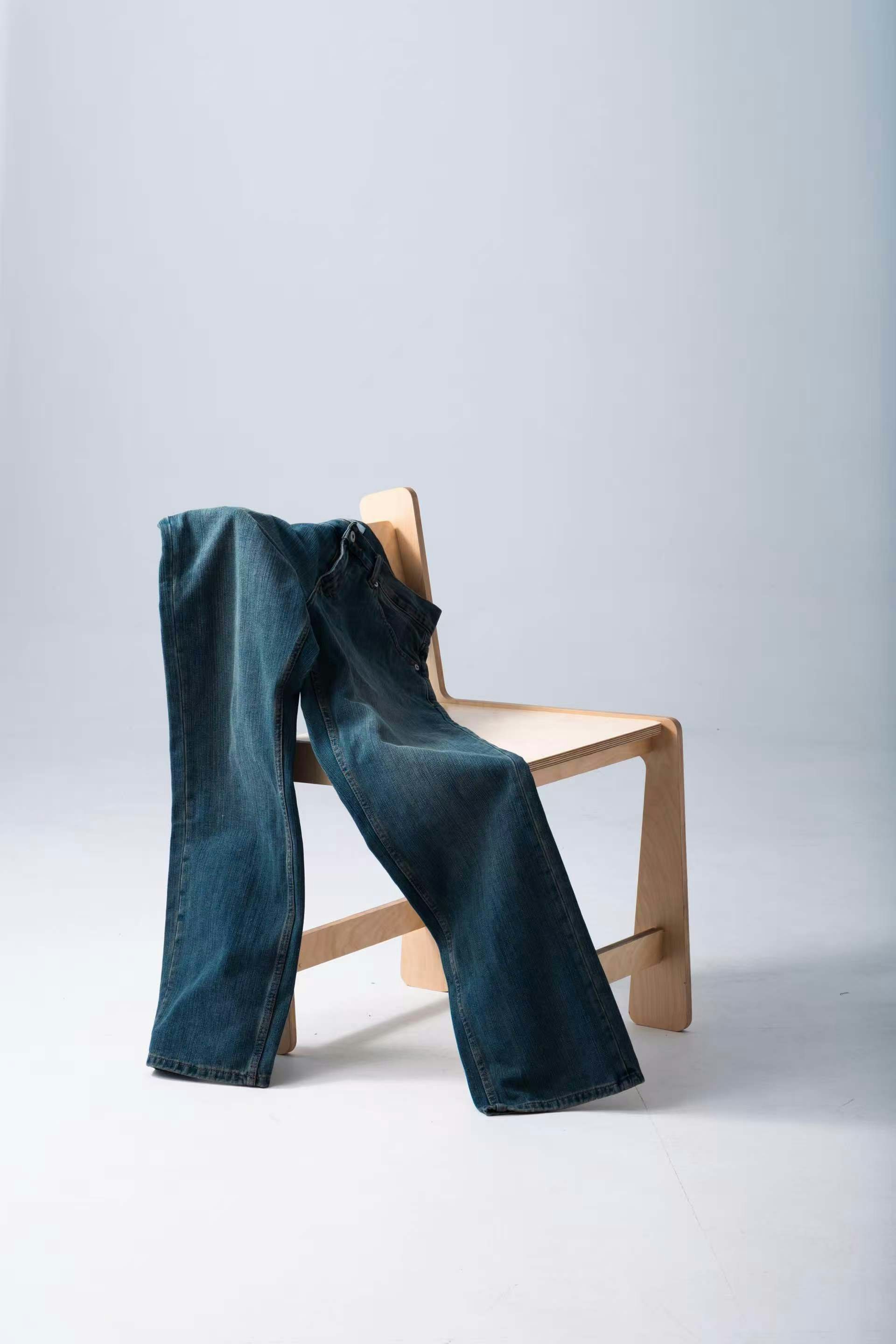 Jeans casually draped over a simple wooden chair. photo – Free Fashion ...
