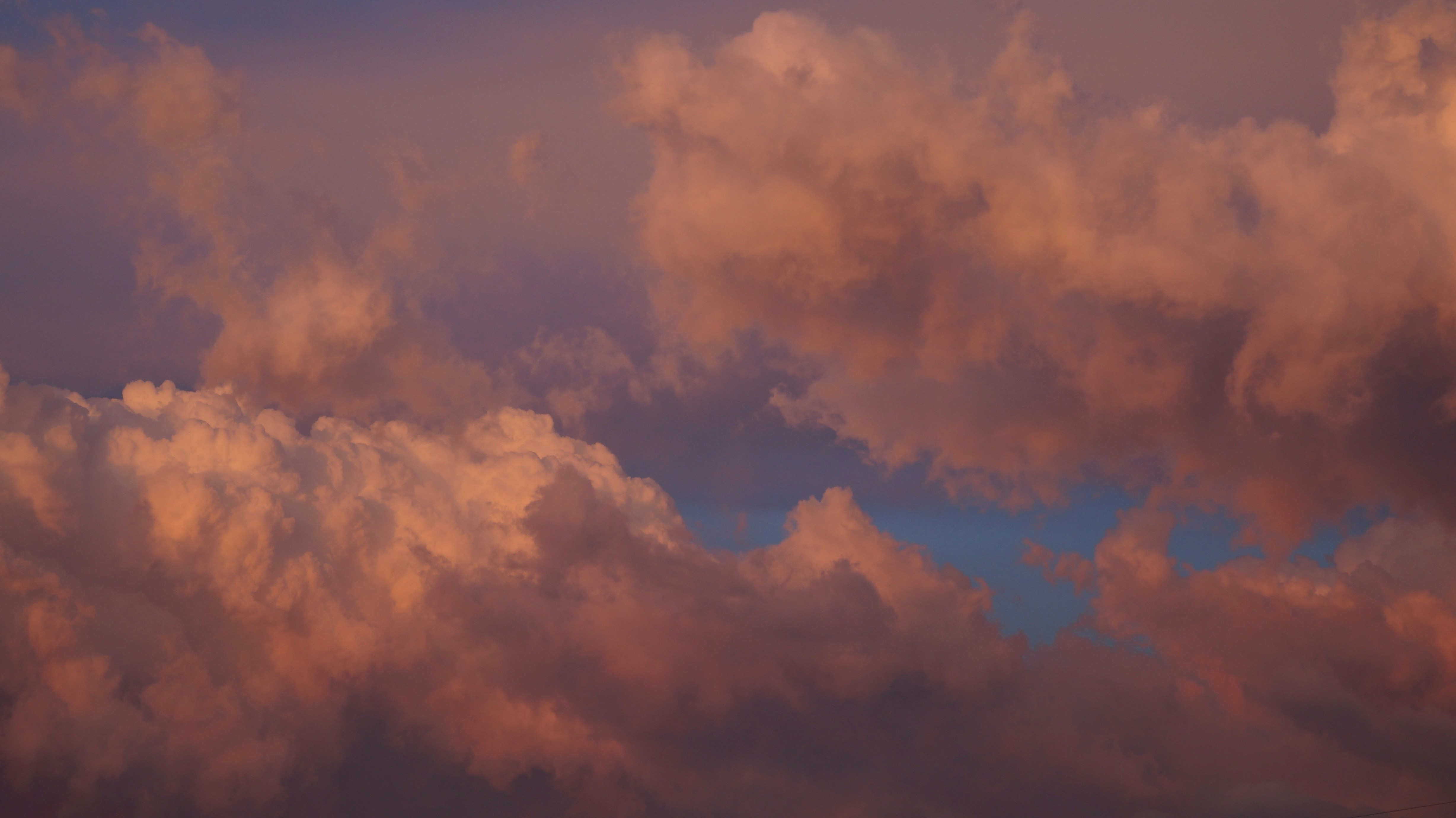 Pink and purple clouds fill the sky.