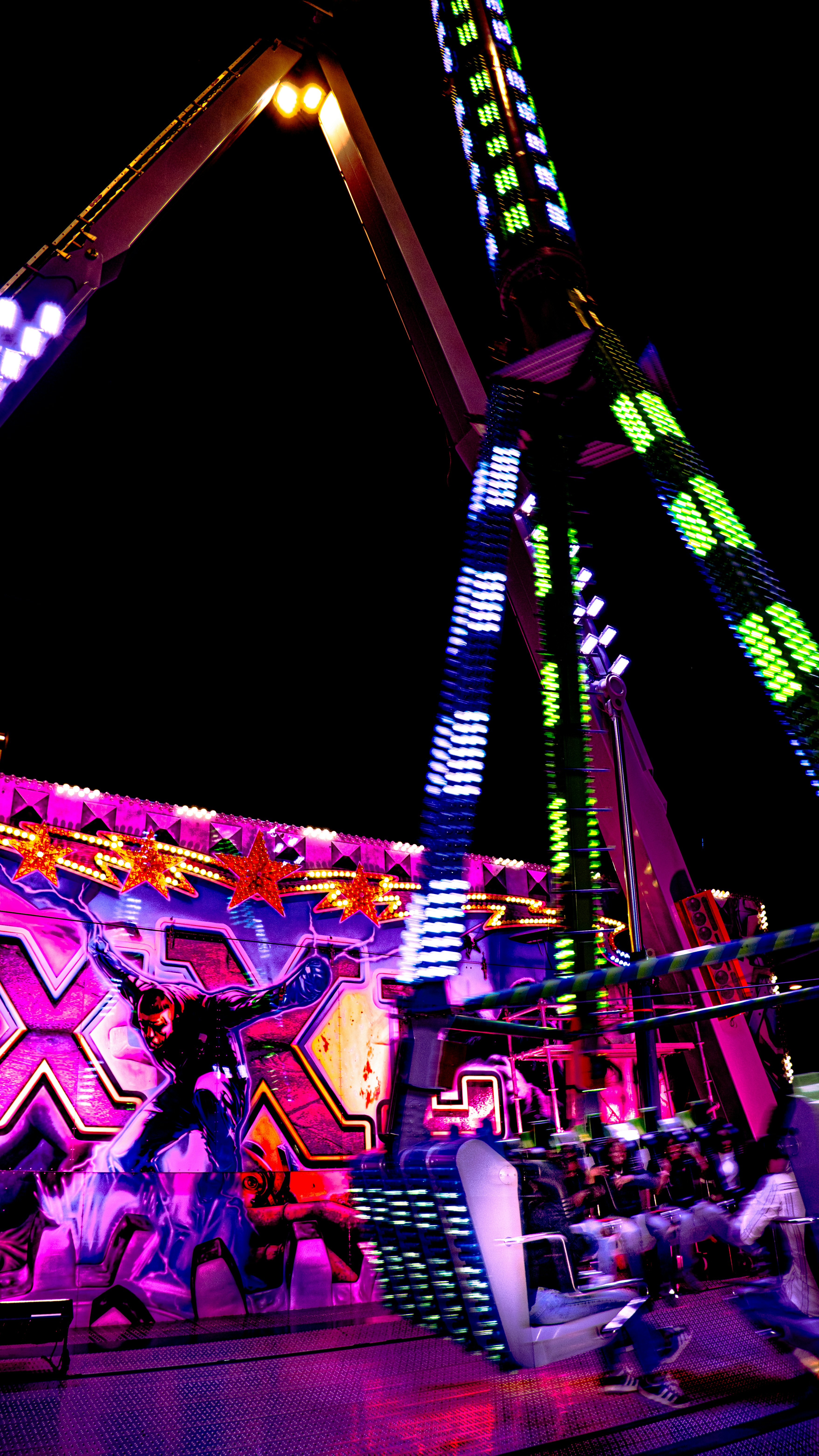 A colorful amusement park ride is lit up.