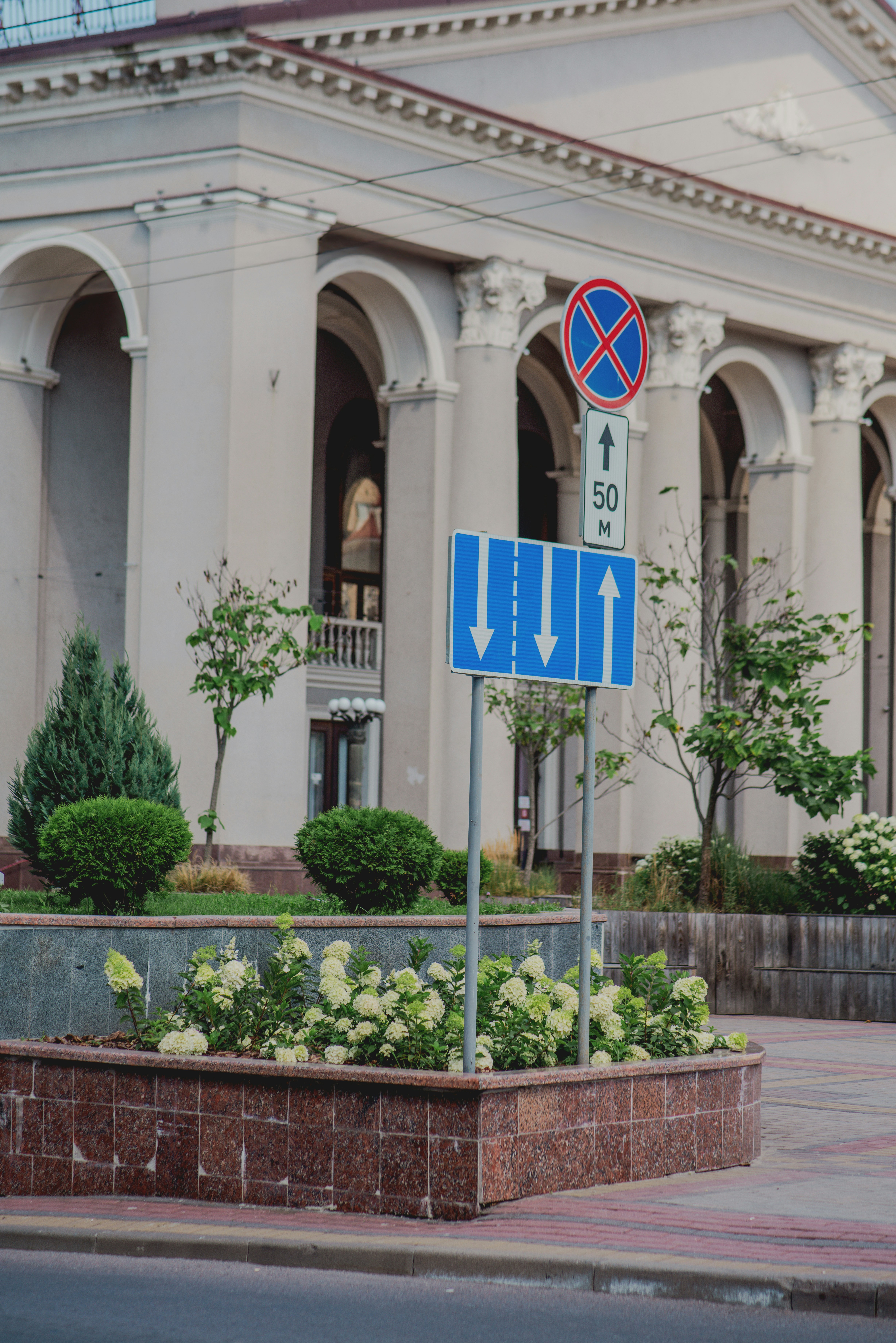 Street signs stand in front of a building.