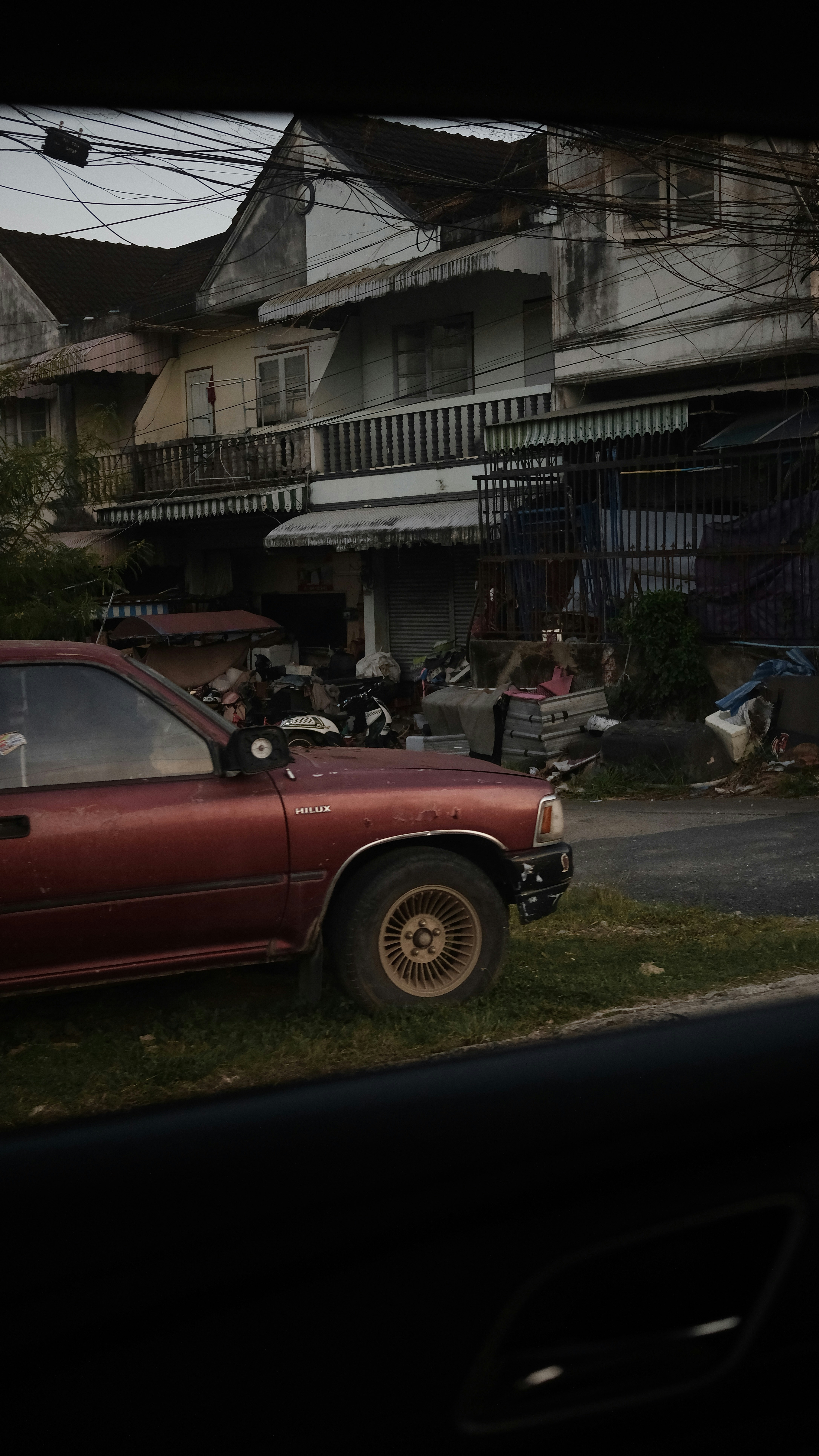 Red car parked near old buildings