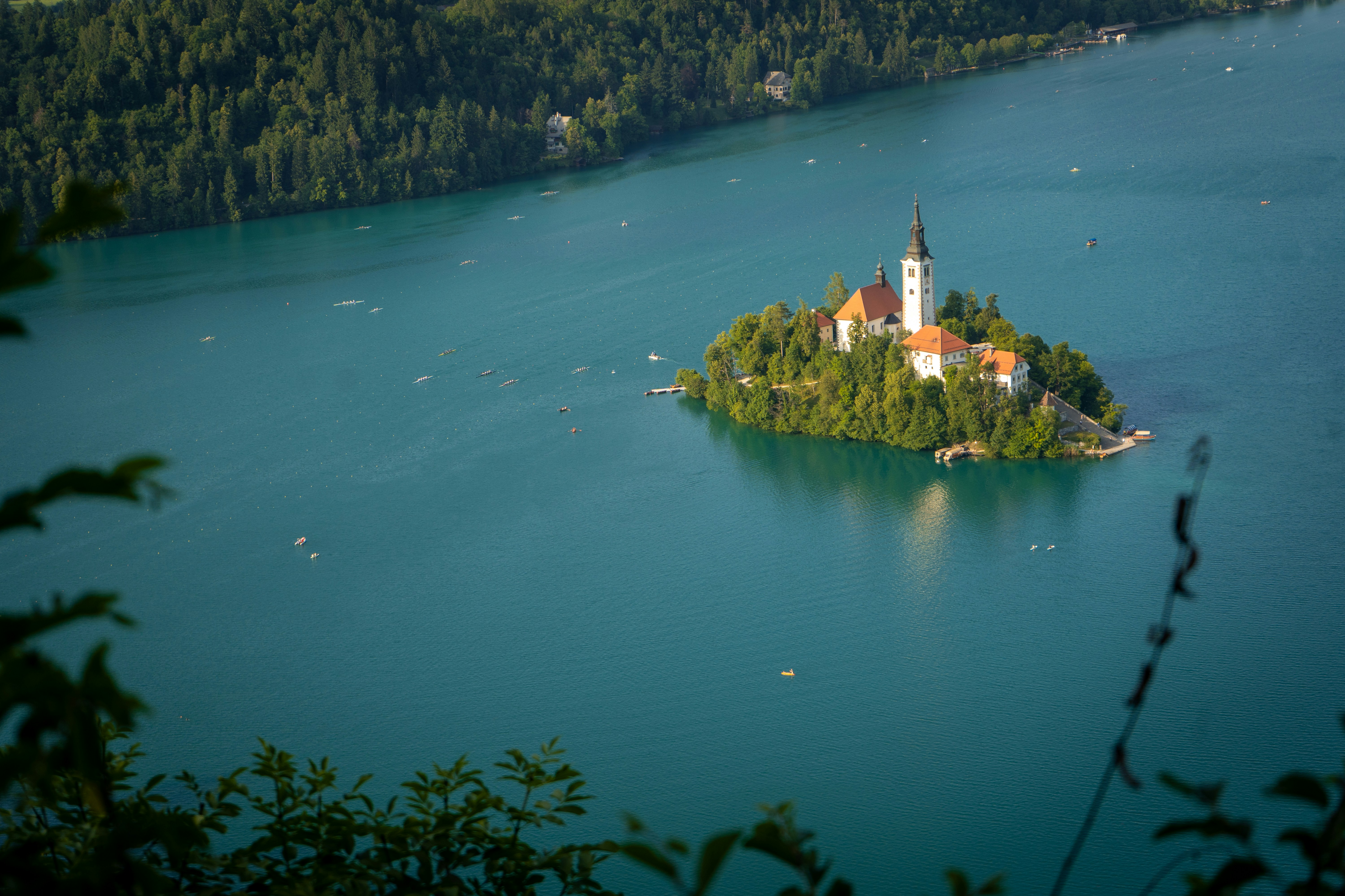 Picturesque island with a charming church nestled amid lush greenery and calm blue waters. The scene reflects a serene escape into nature.