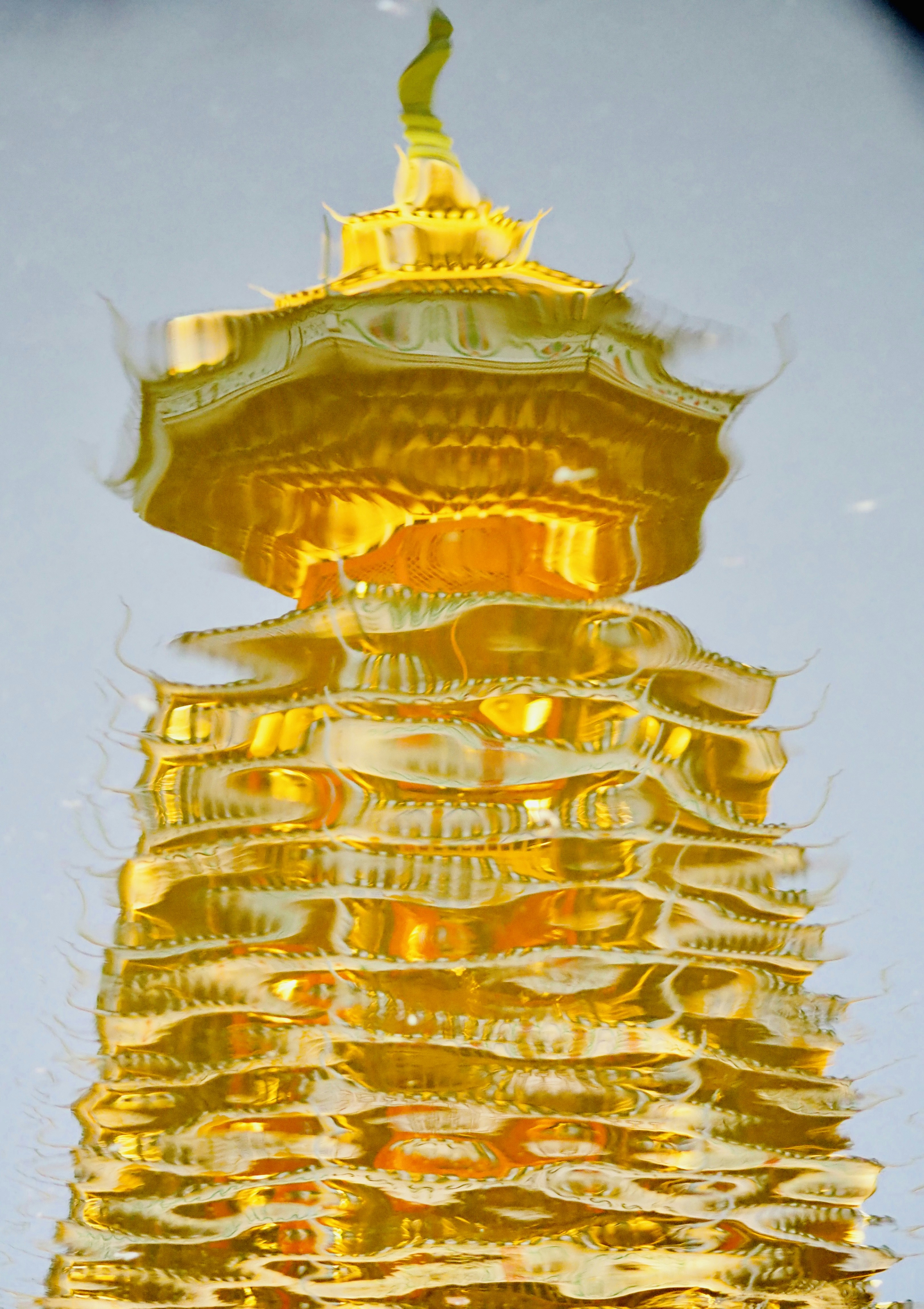 Golden Reverberations: A Tower's Reflection