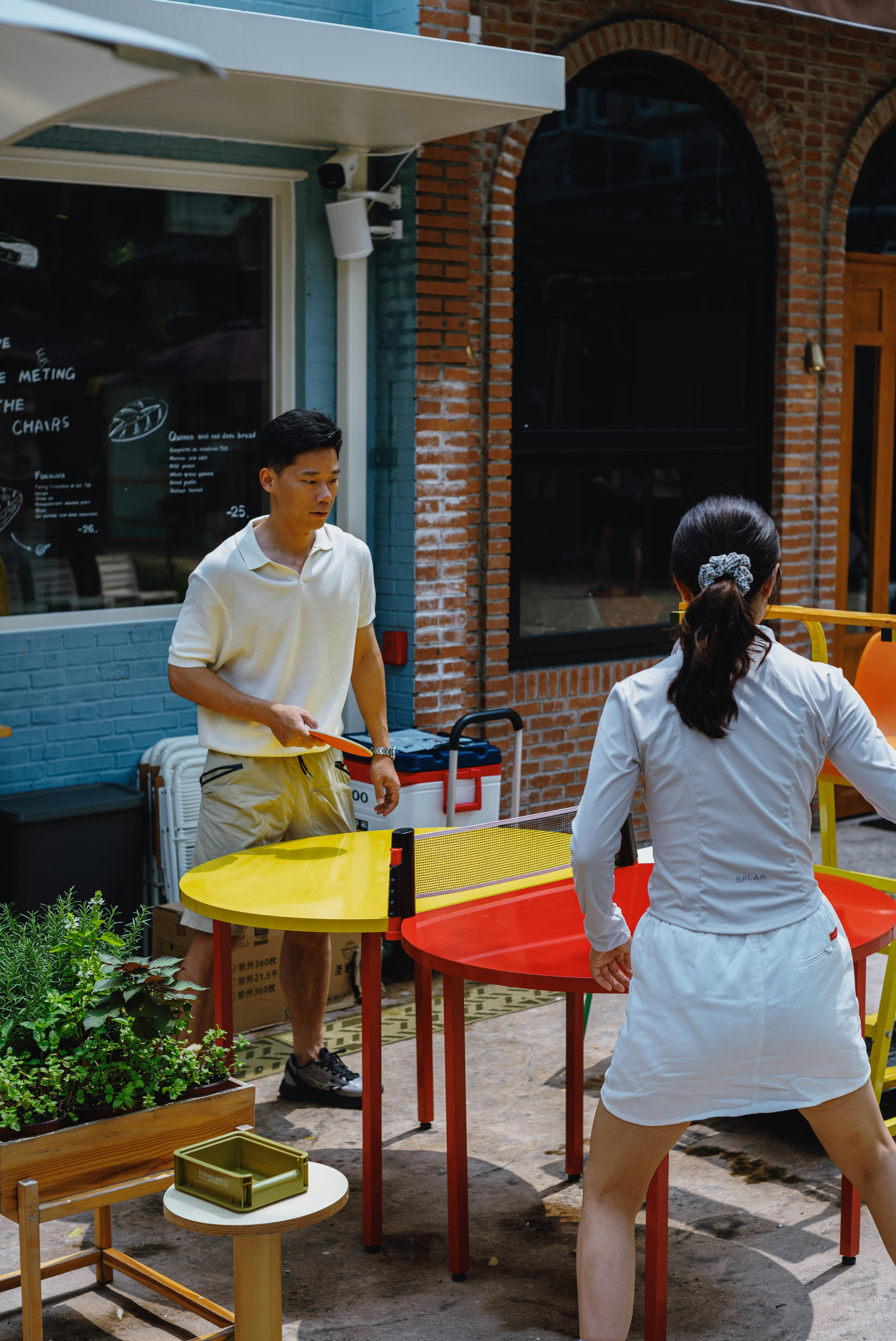 Sunlit Pause by Bright Tables in a Brick Courtyard