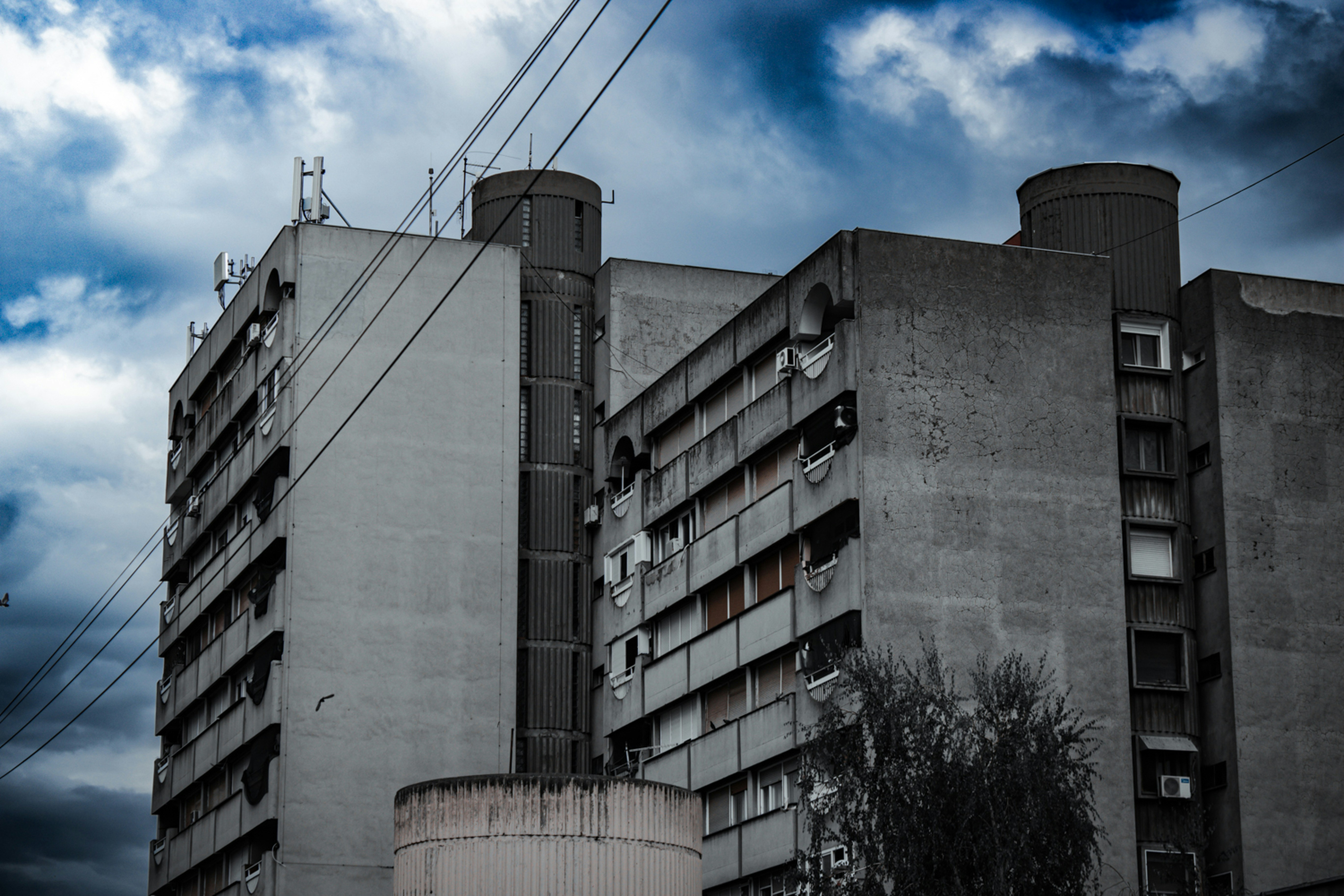 An ominous, concrete apartment building stands tall. photo – Free ...