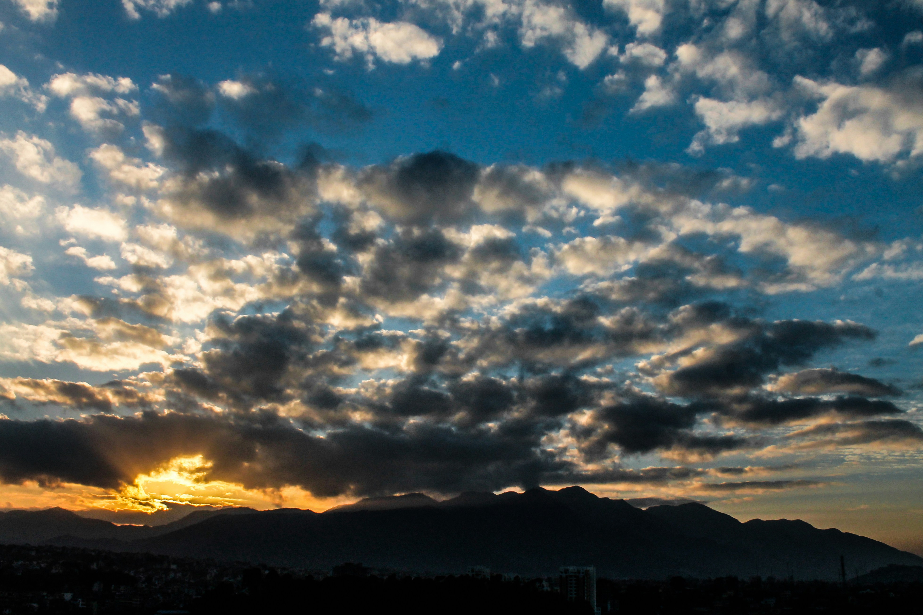 Golden Hour Magic: Sunset in the Hills of Nepal | Dramatic clouds and sunset above mountains.
