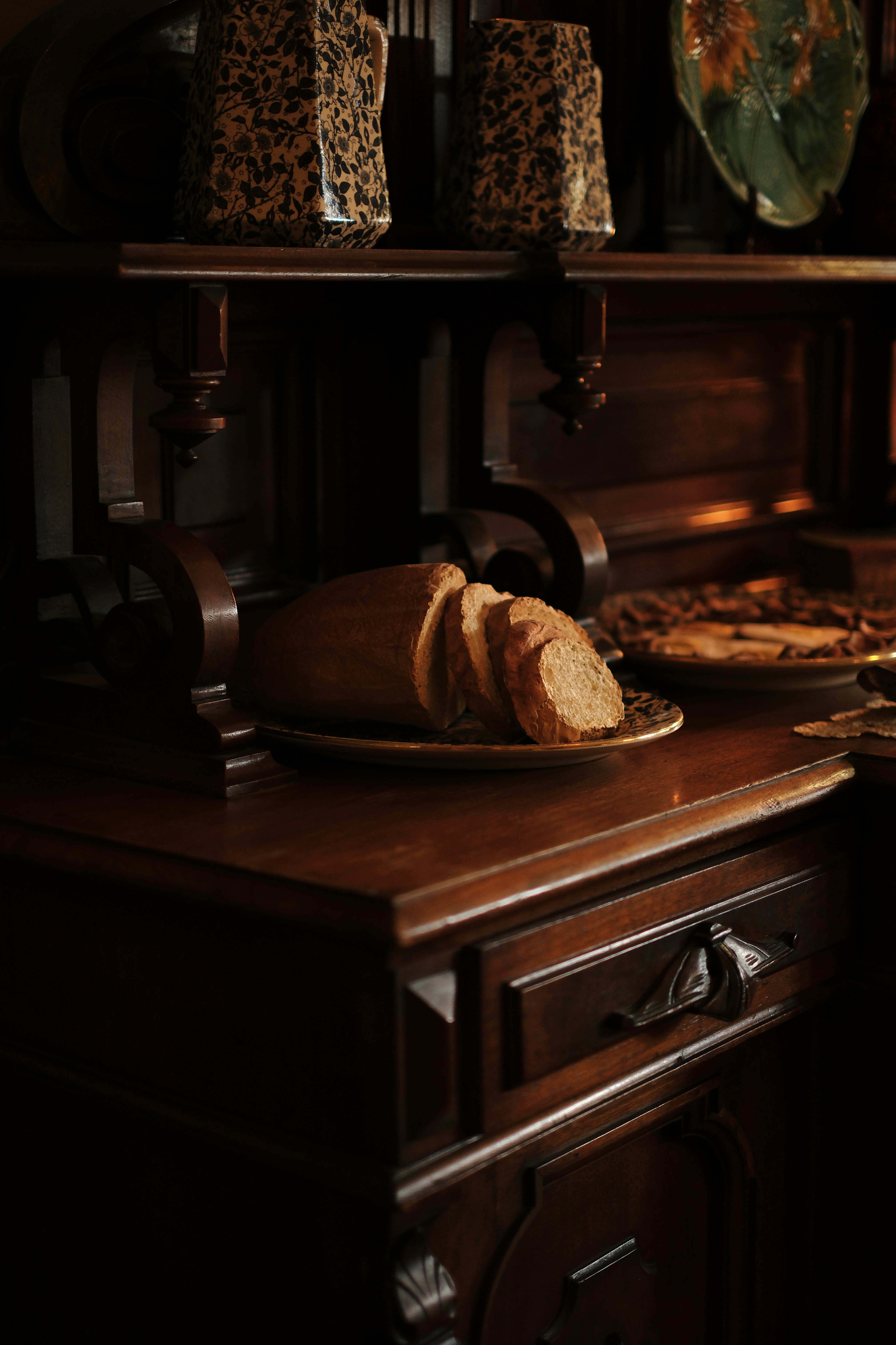 Instagram - @kaprion | Bread sits on a wooden cabinet.