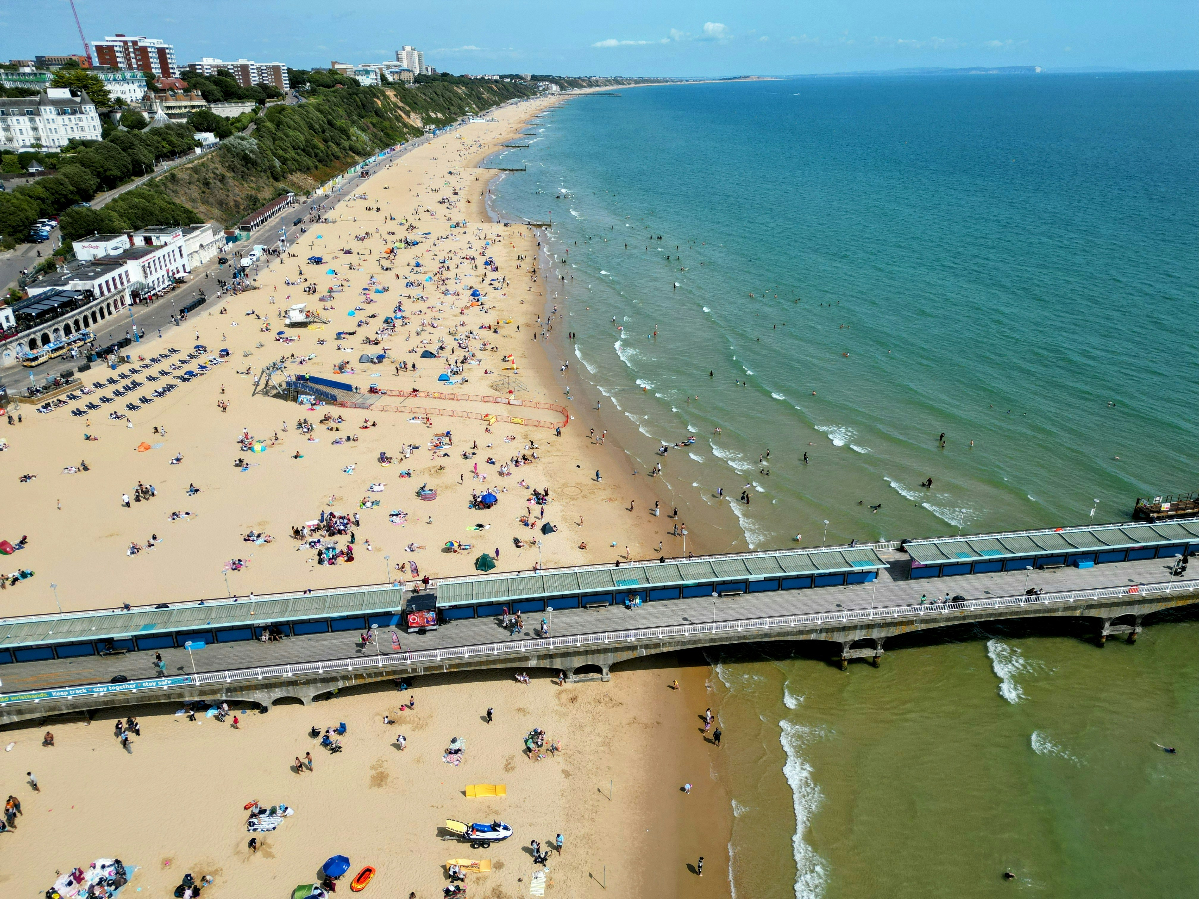 Bournemouth beach | A busy beach is filled with people and water.