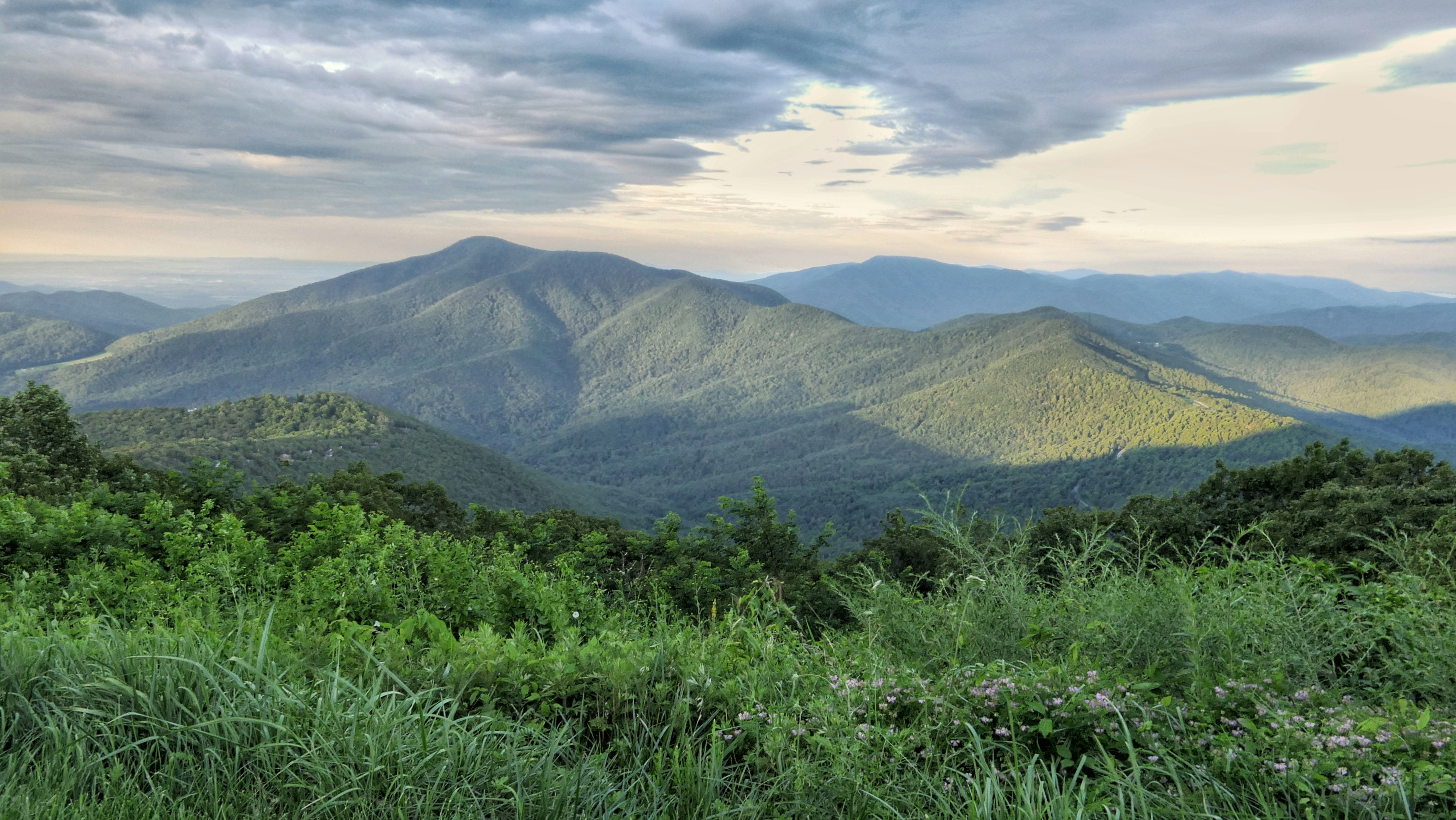 Blue Ridge mountains, the second oldest range on the planet | Mountains rise under a cloudy sky.