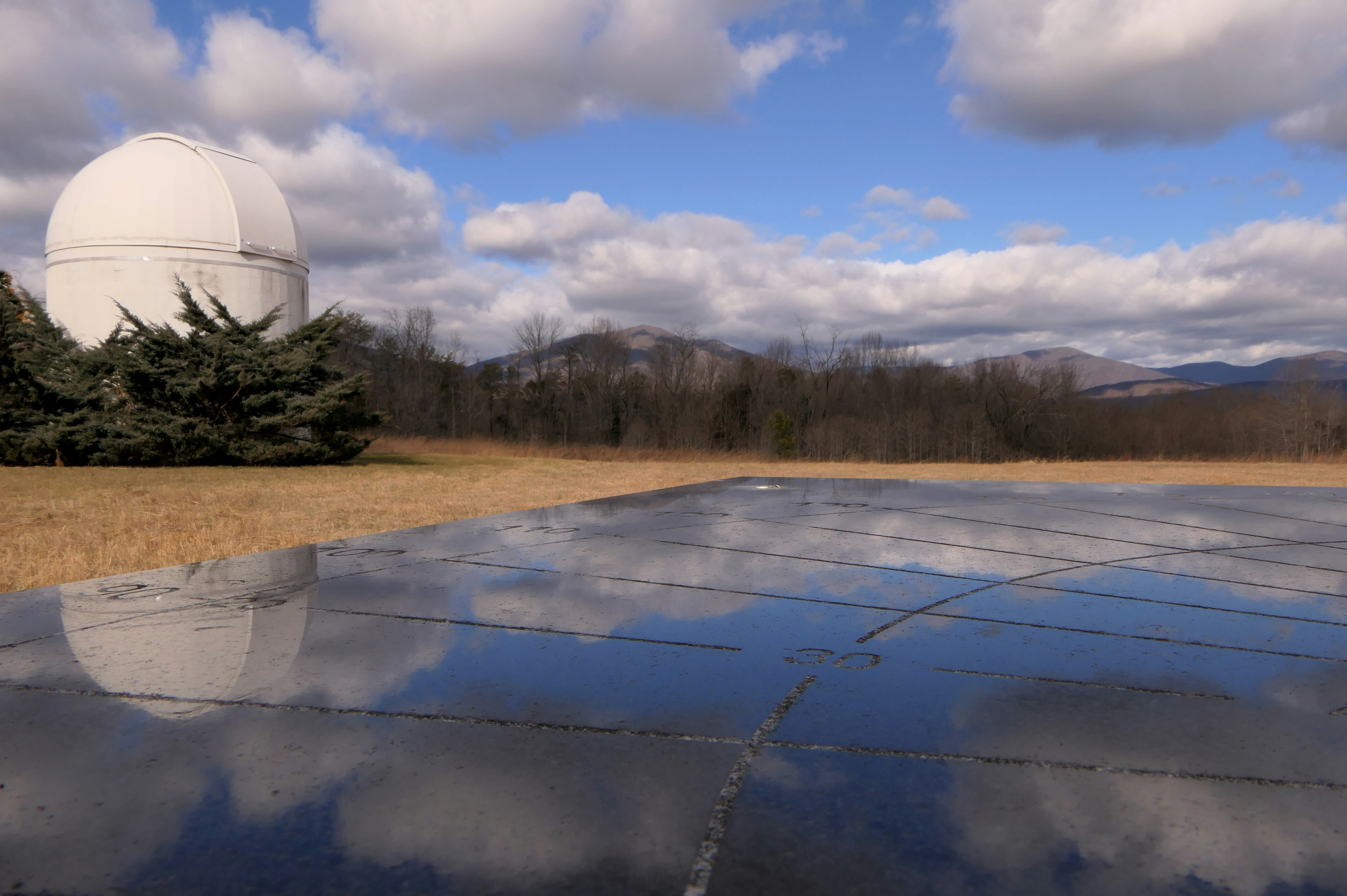 reflection of observatory | Observatory with reflective surface under a cloudy sky.