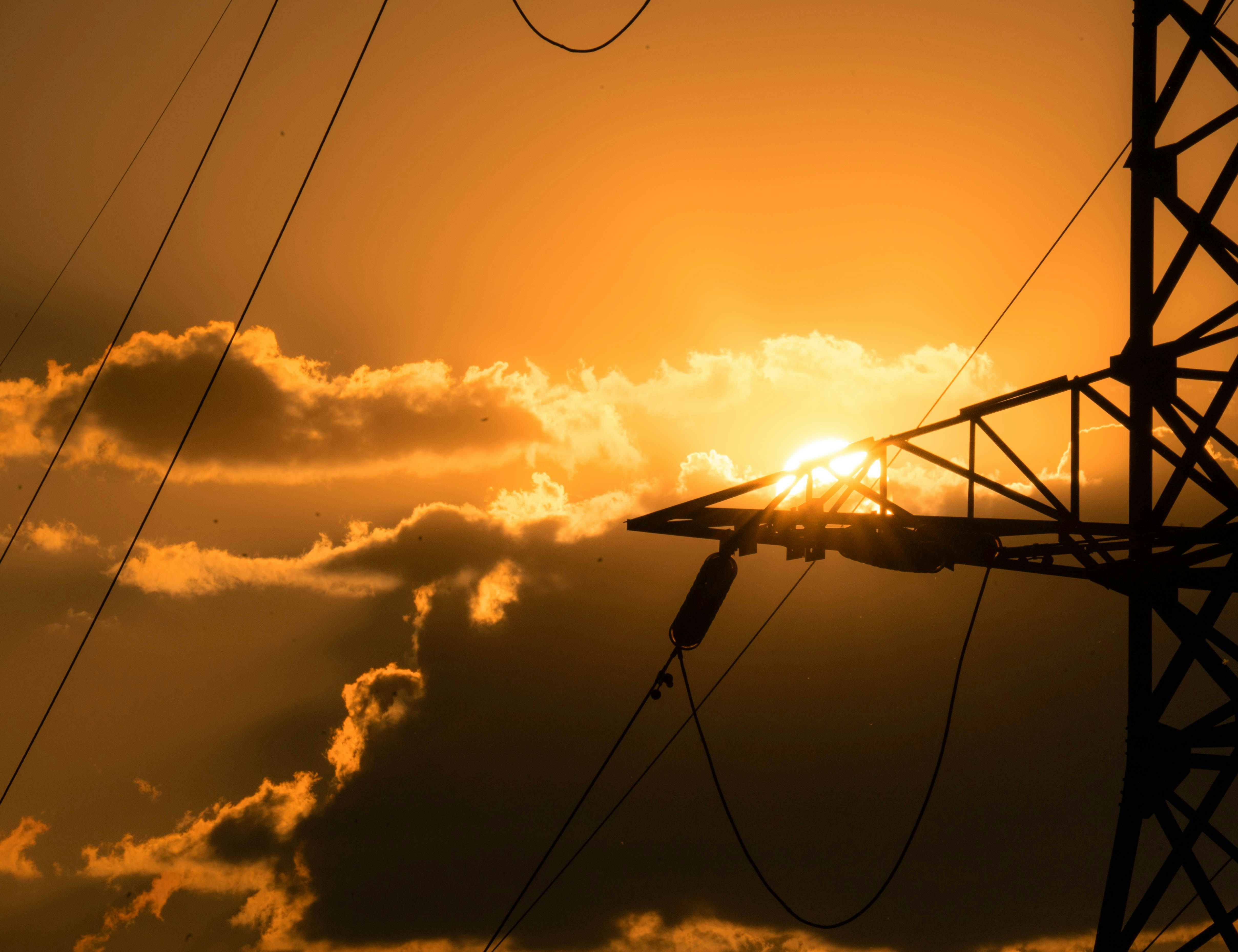 Auric Twilight Across the Silhouette of Transmission Lines