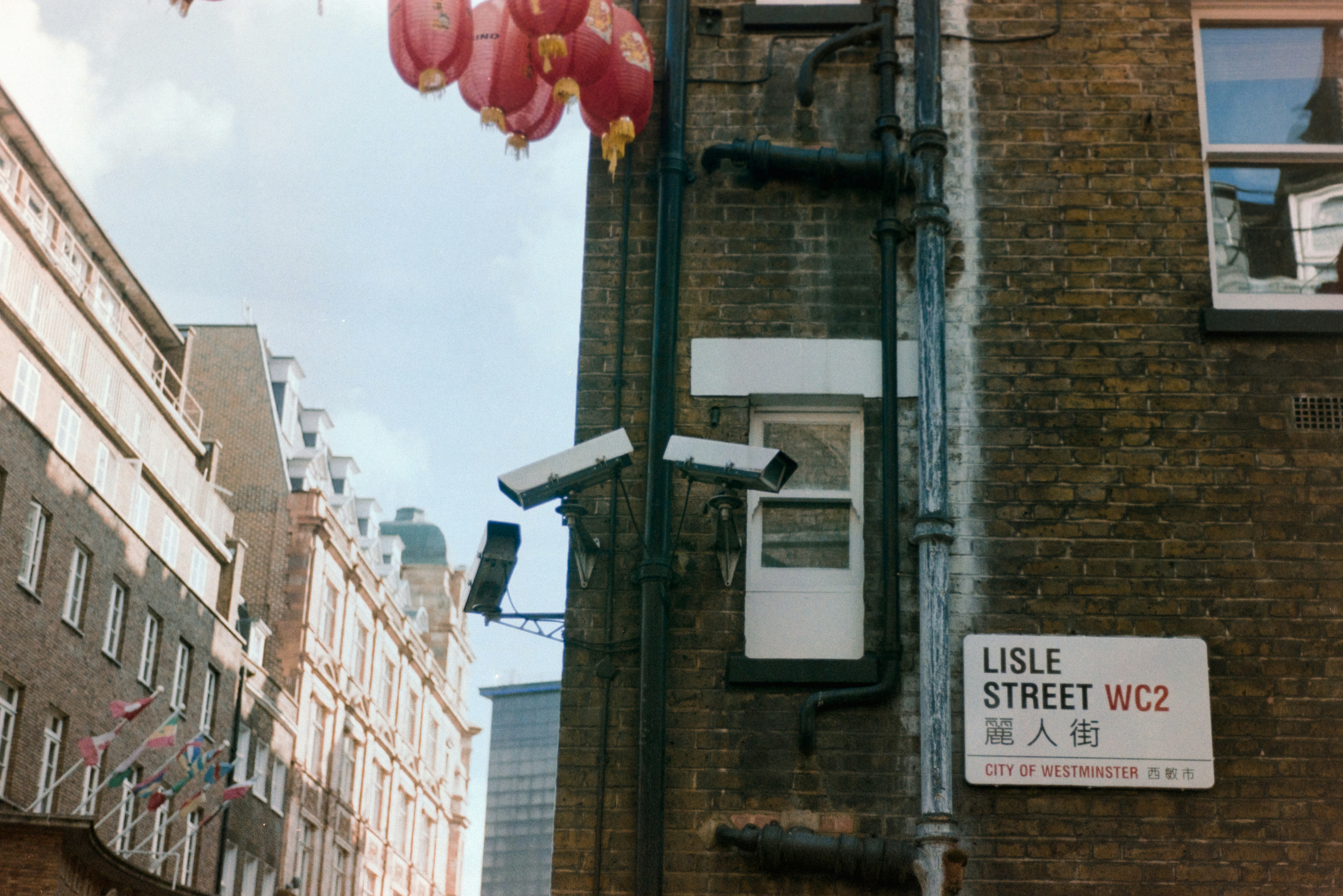 Cctv cameras on lisle street, decorated with lanterns.