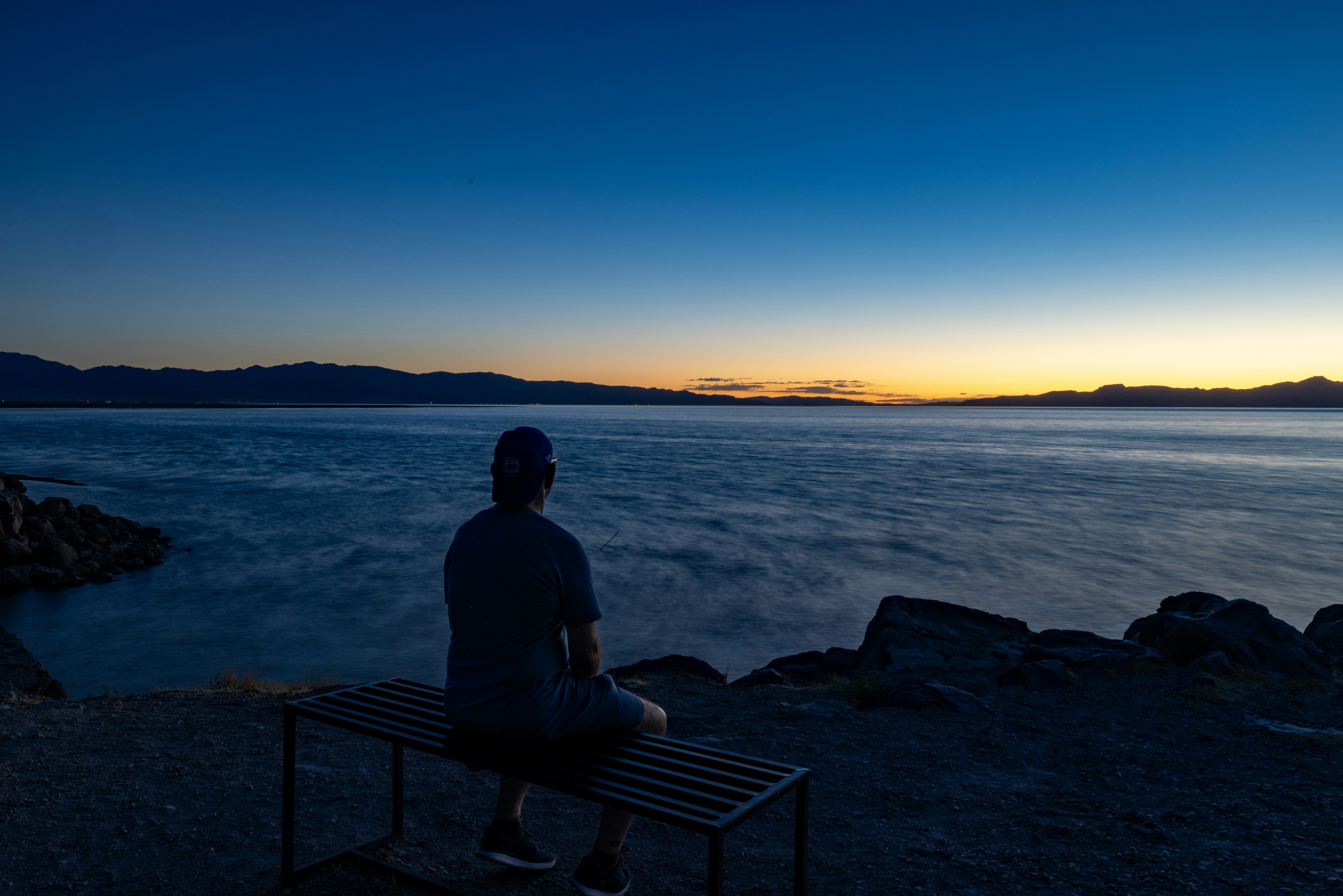 pensive moment | Man enjoys a sunrise by the water.