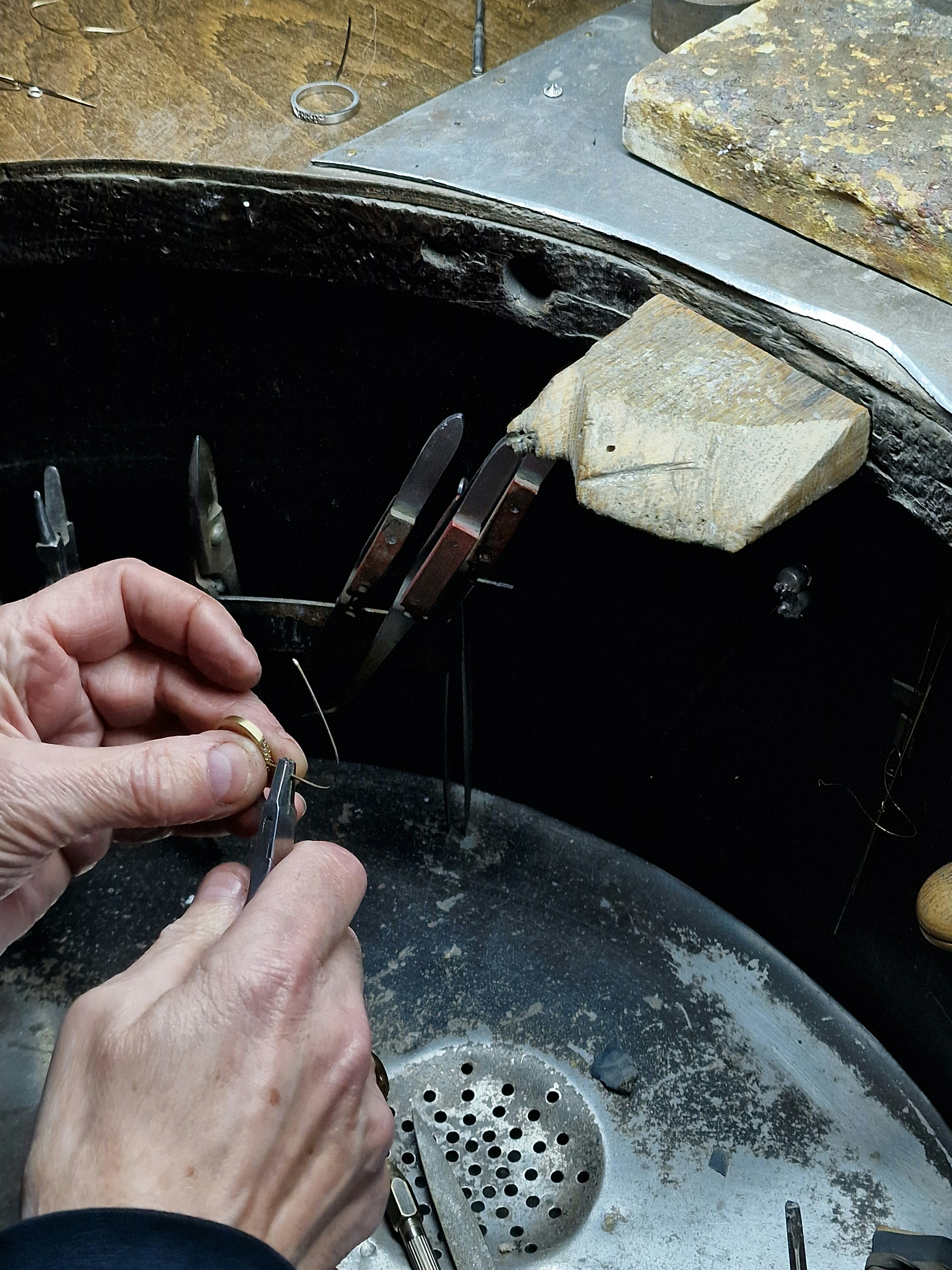 Jeweler working with a ring in a workshop.