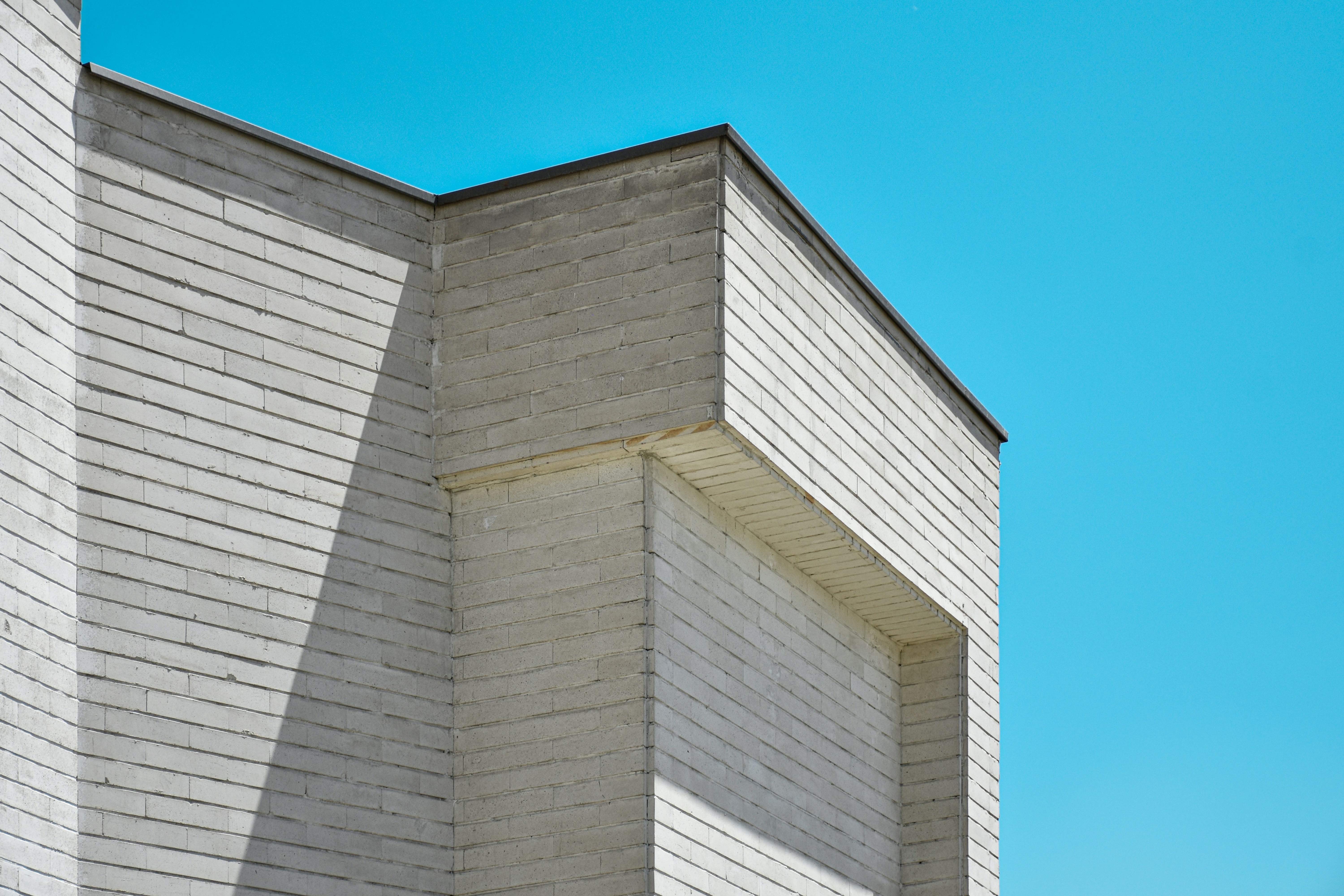 Building's corner against a bright blue sky.