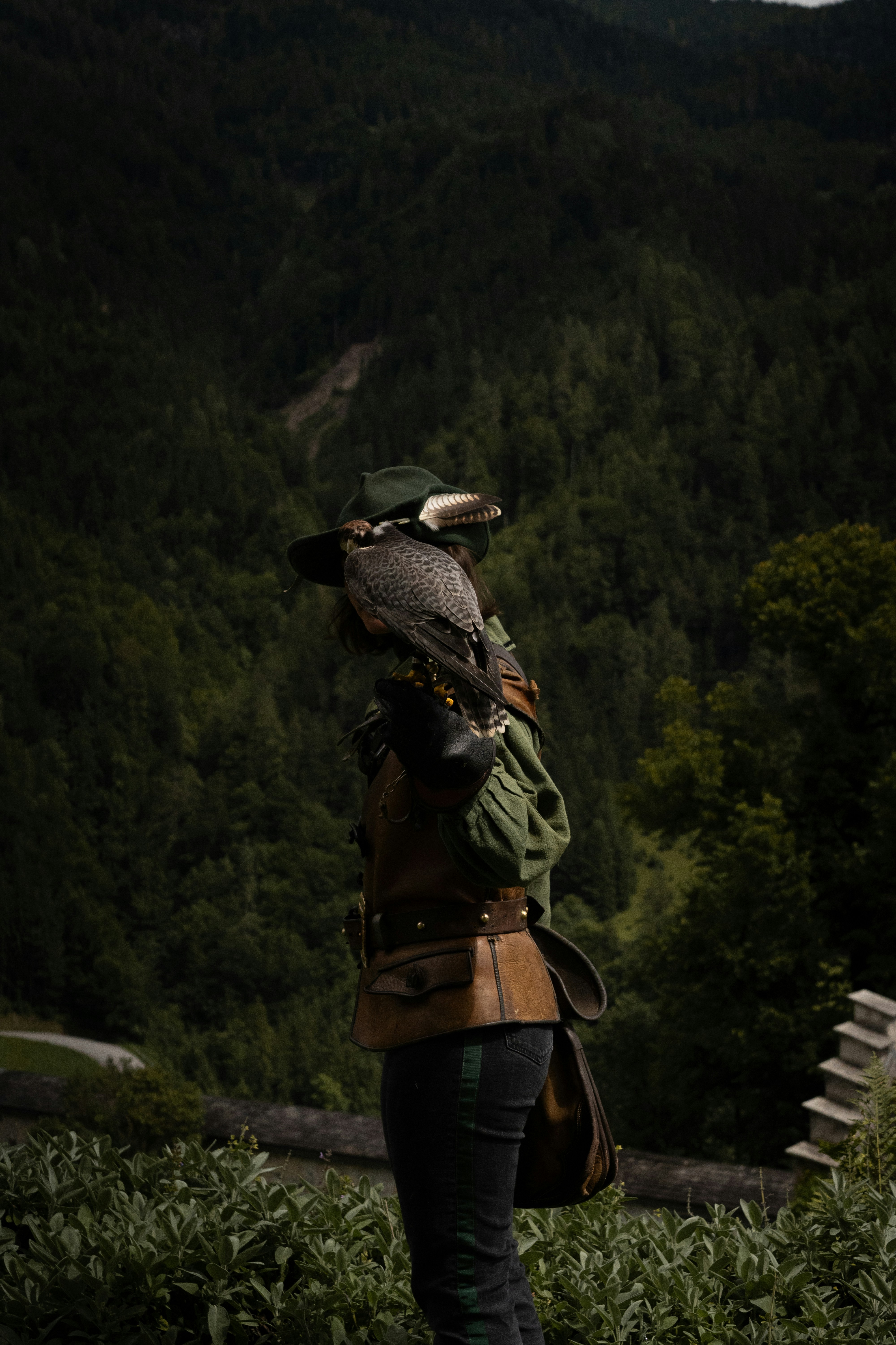 A falconer poses with a bird of prey.