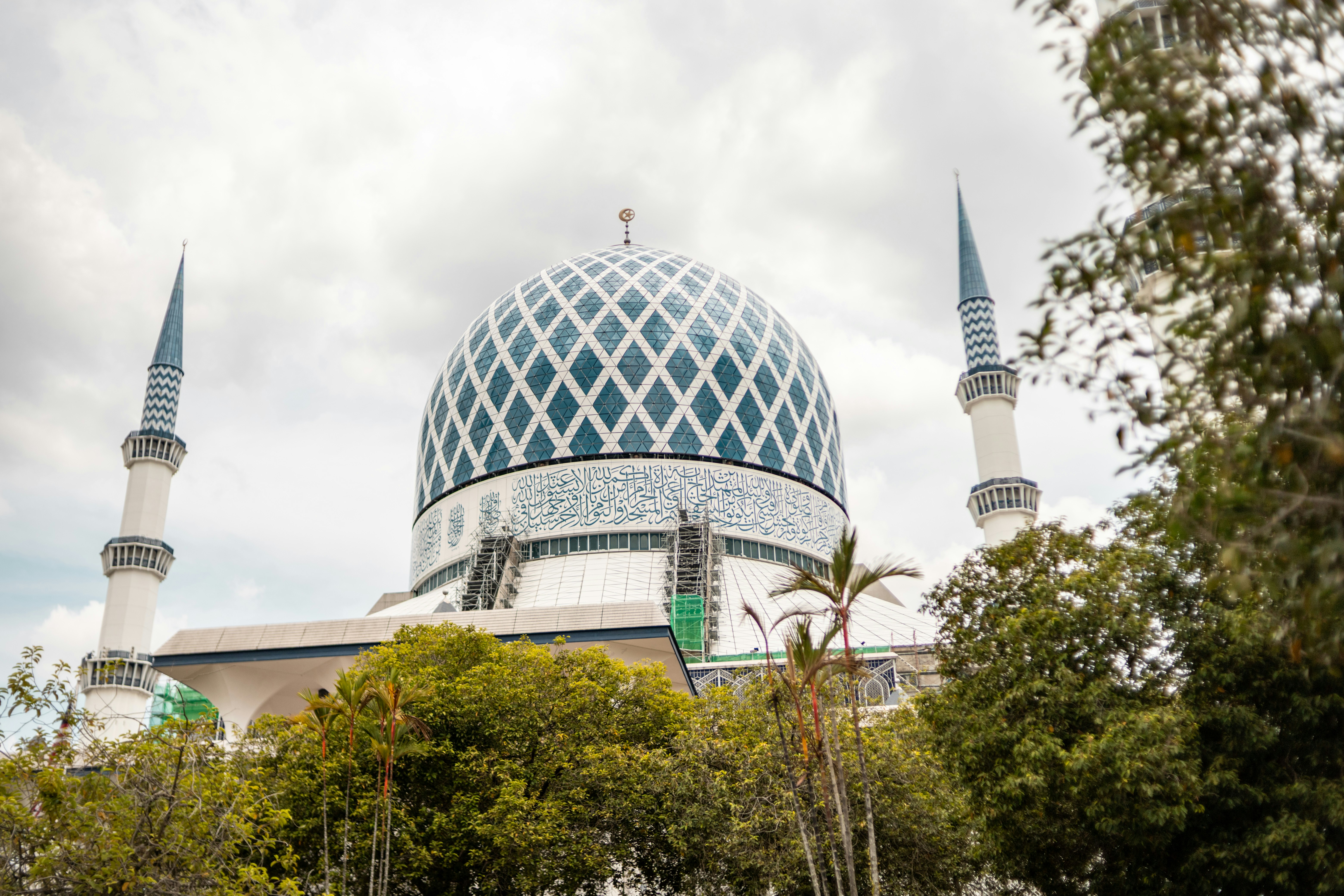 A beautiful mosque with blue dome and minarets.