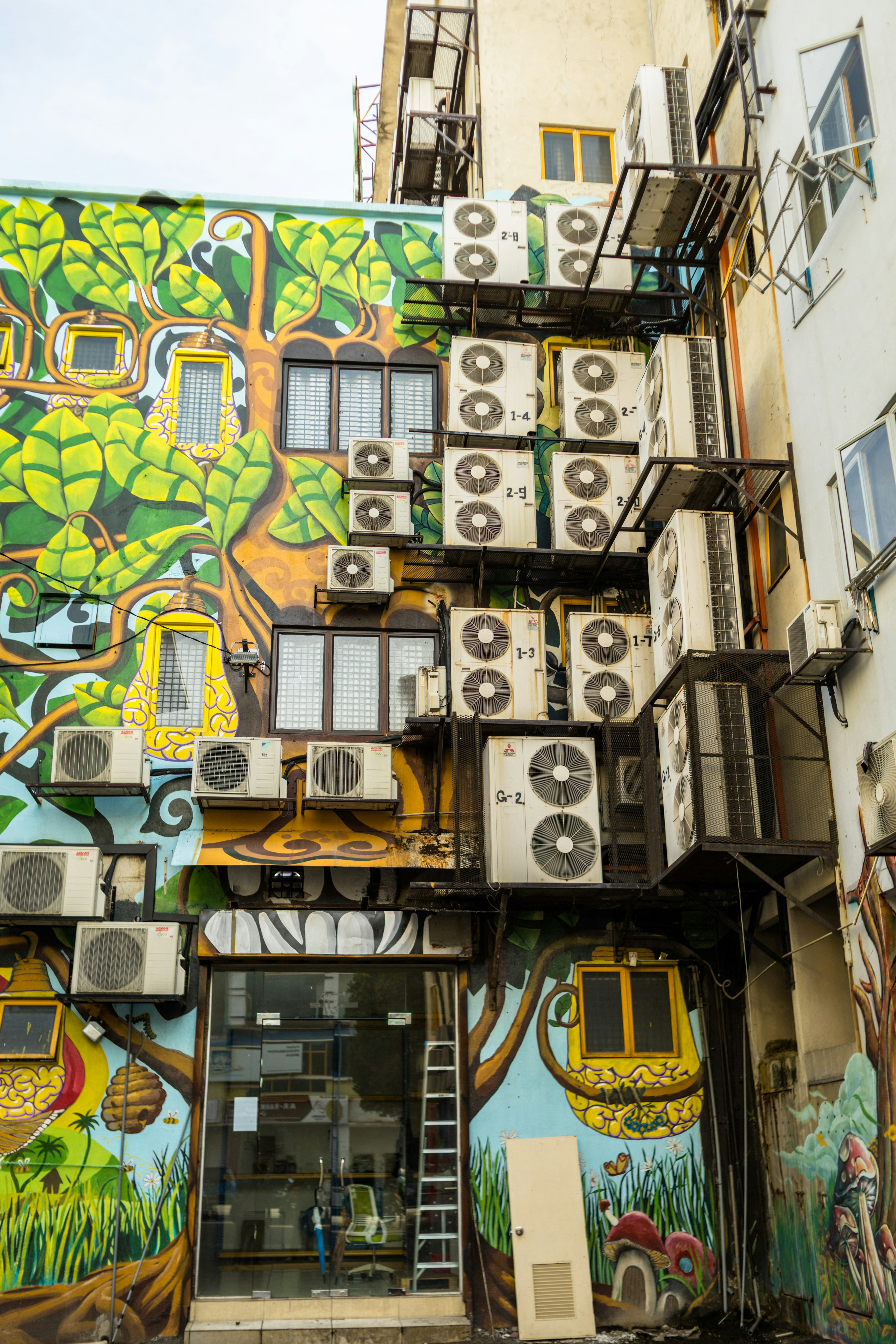 Buildings are covered in graffiti and air conditioning units. photo ...