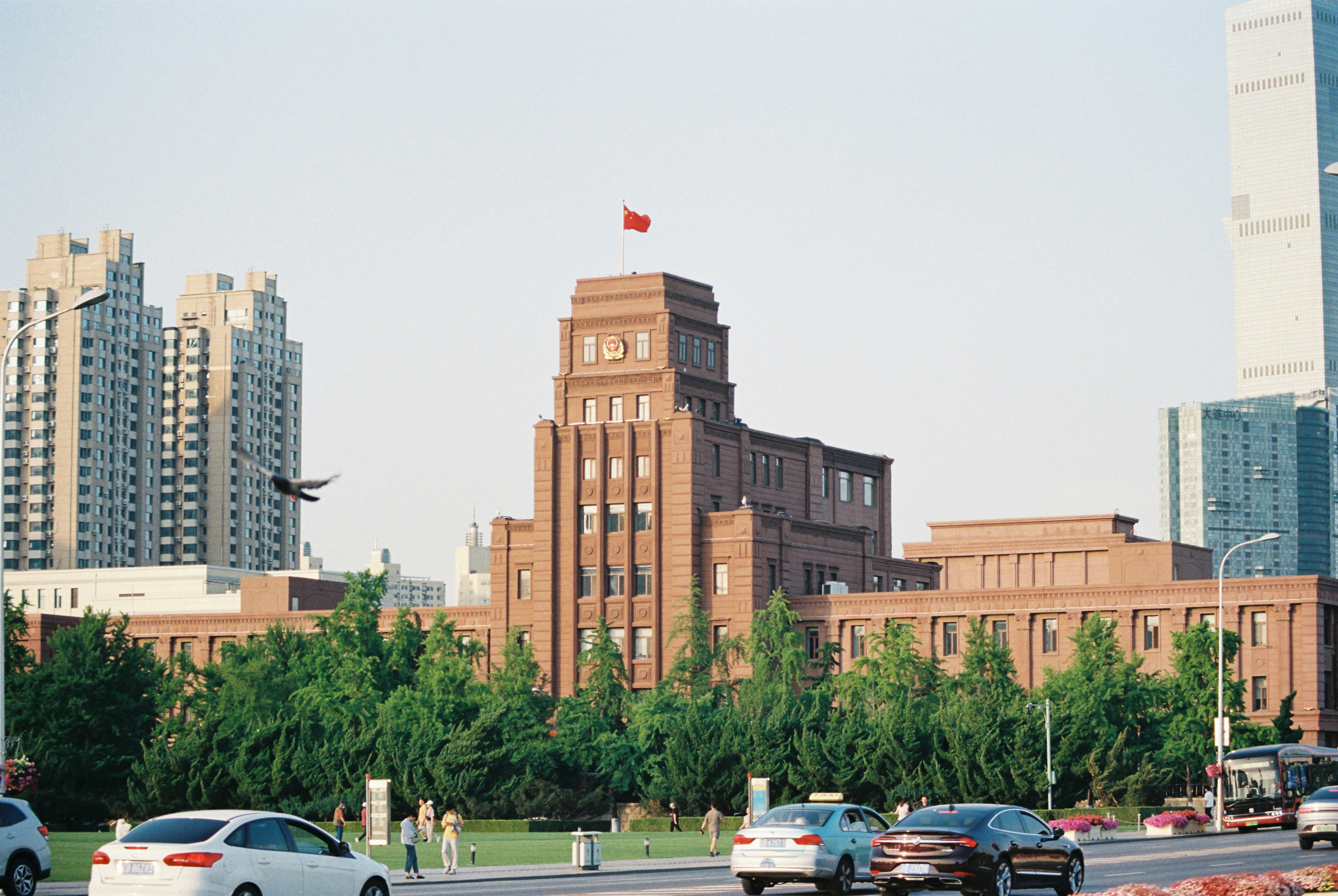 Brick building with a chinese flag on top.