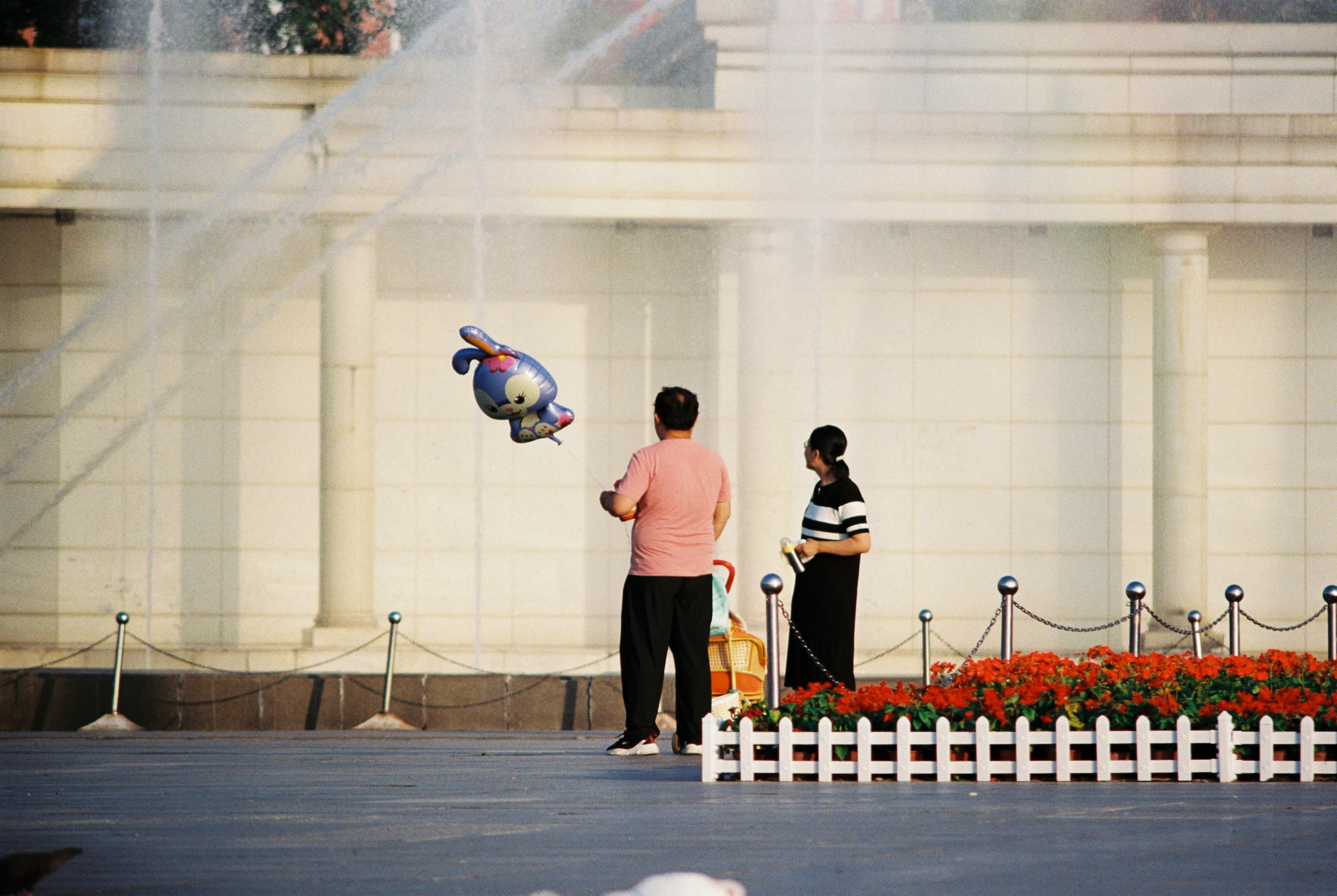People watch a floating cartoon balloon.