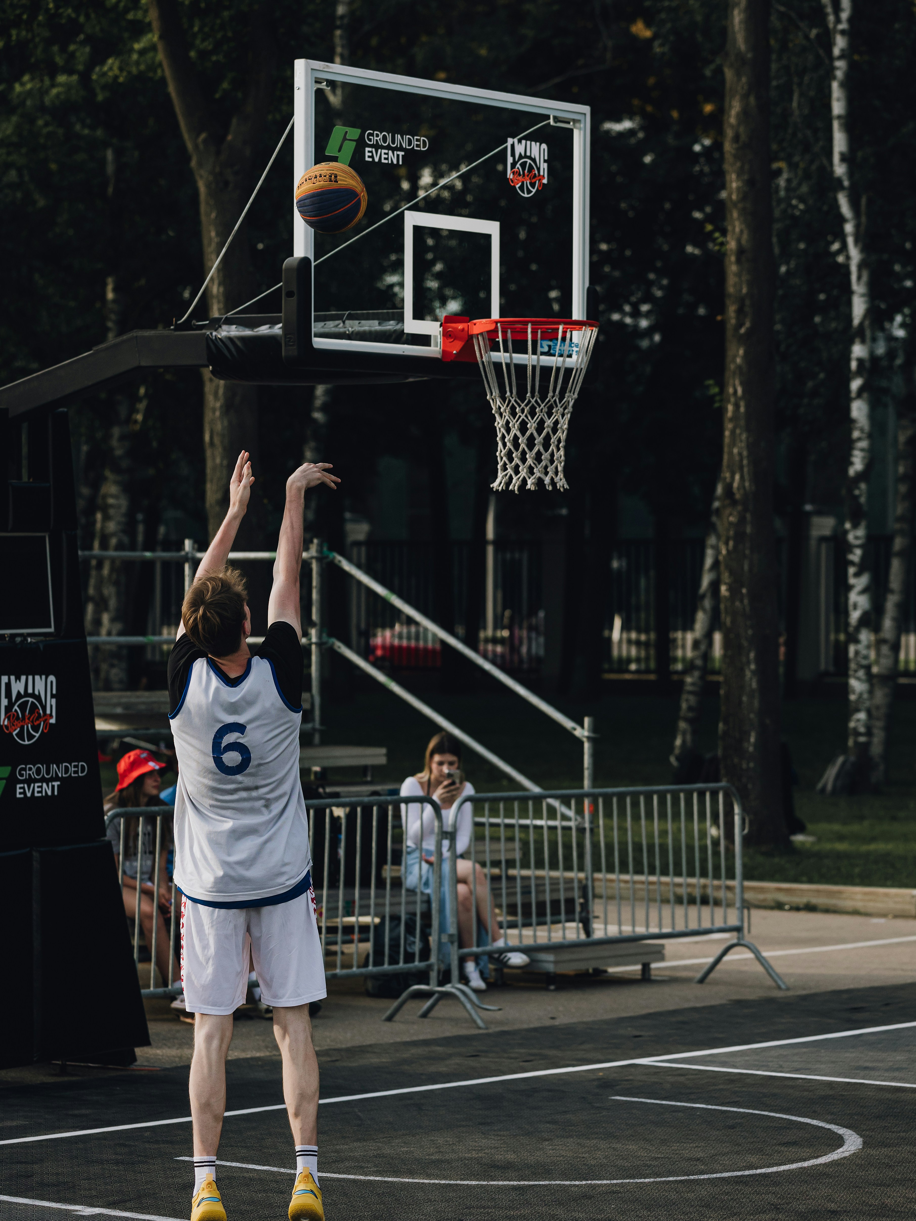 Man shooting a basketball towards a hoop