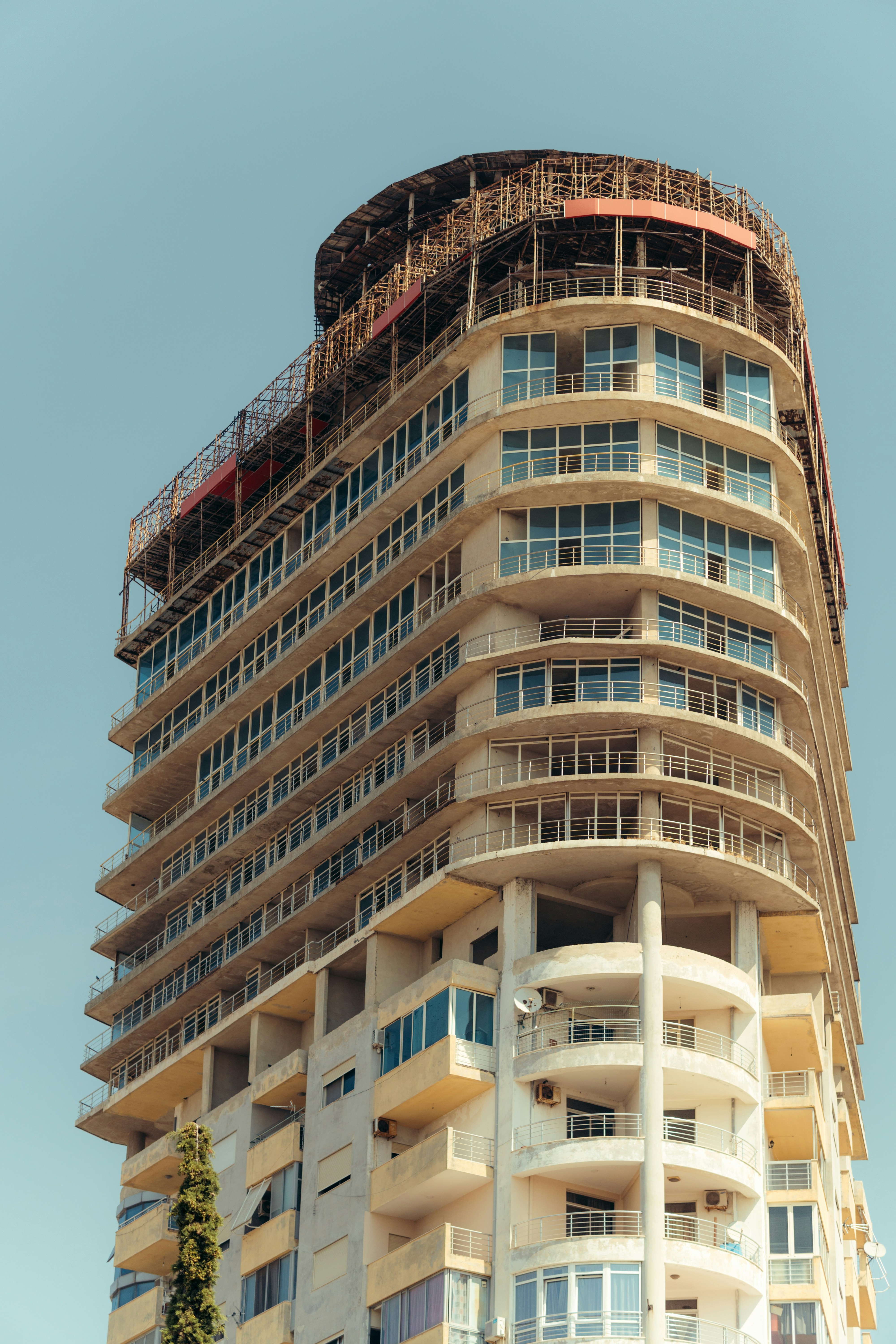 Modern building under construction against clear blue sky