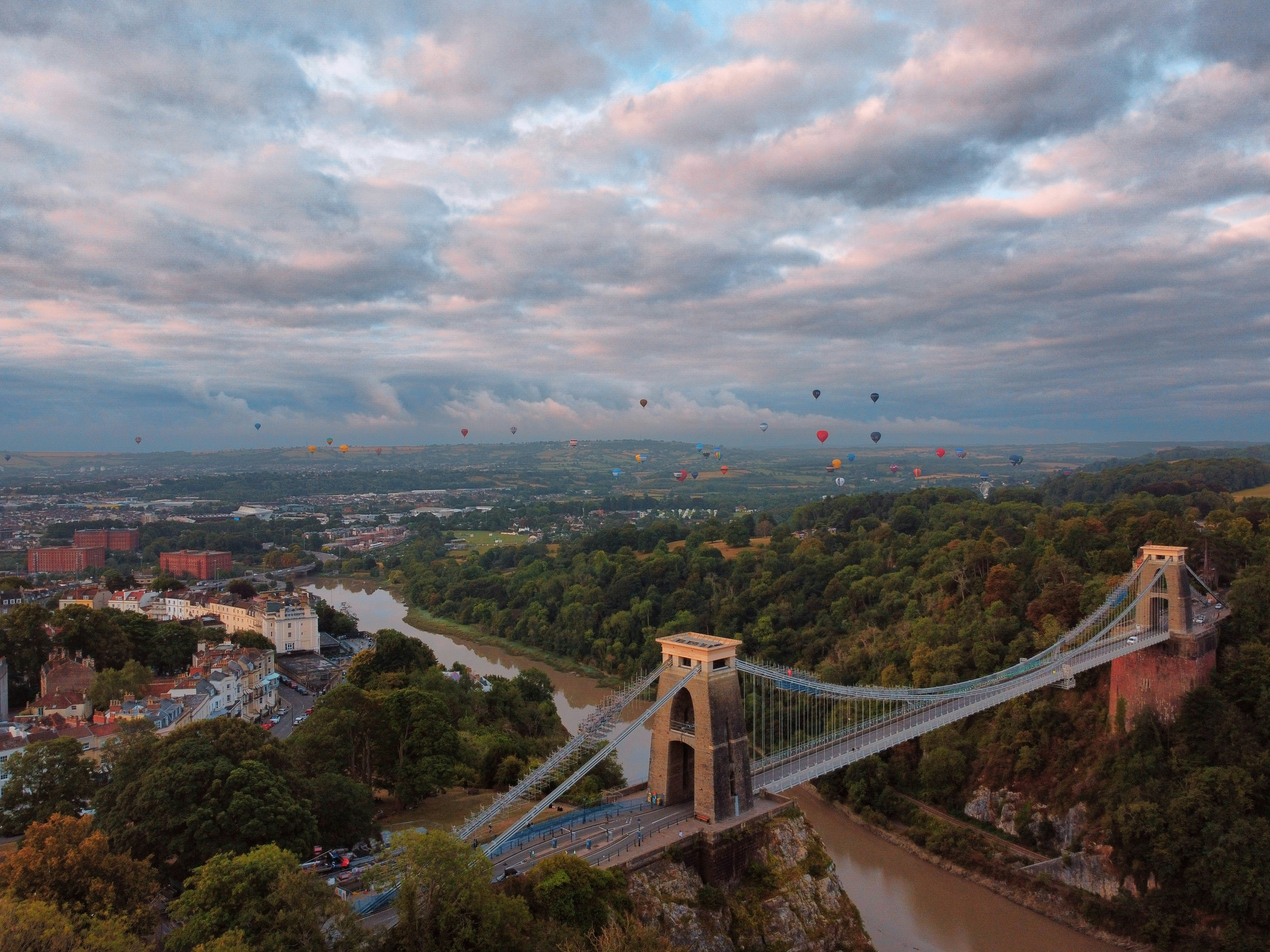 Hot air balloons over clifton suspension bridge at sunset