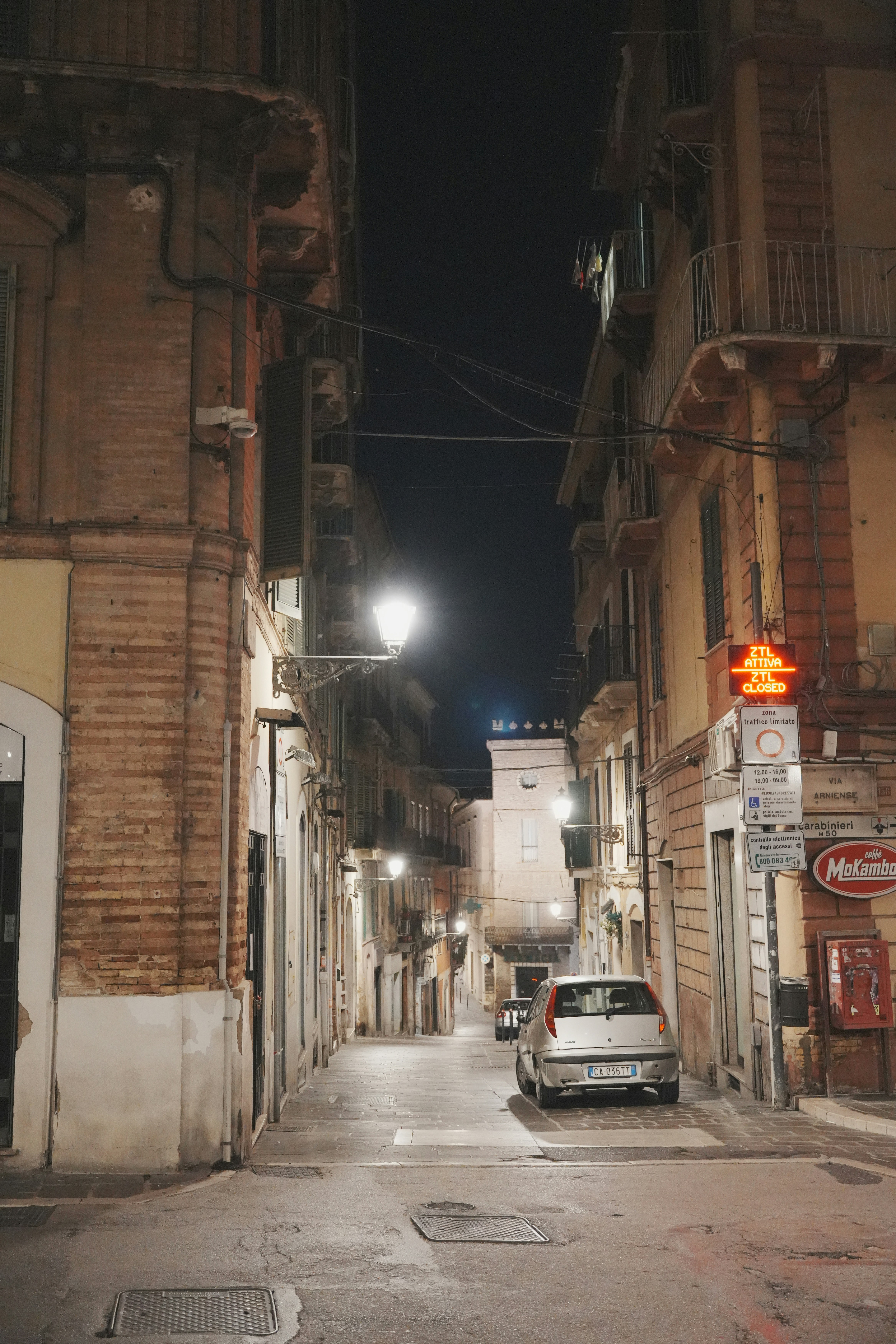 A narrow street in an old european town at night.