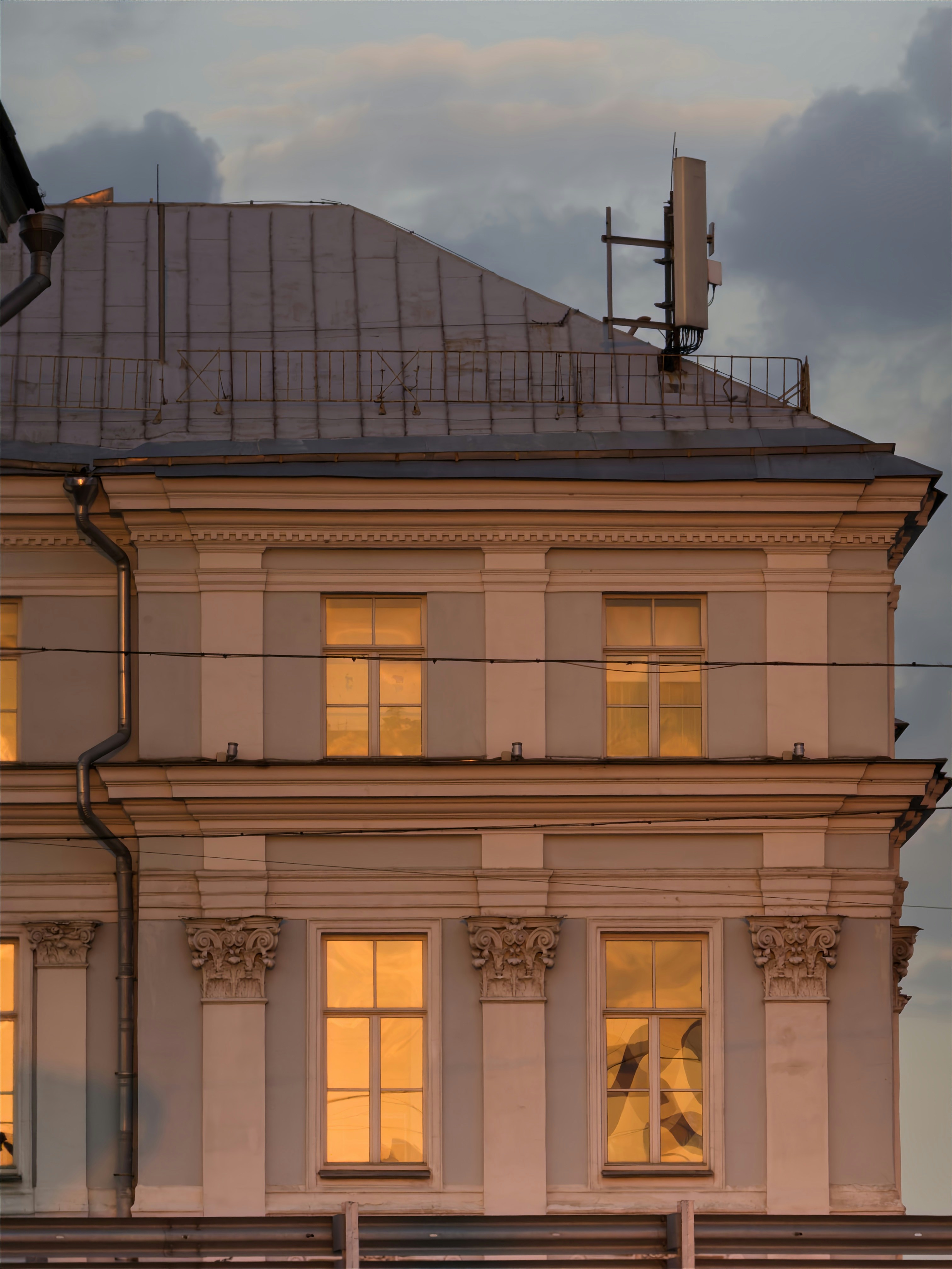 Building facade with illuminated windows at dusk