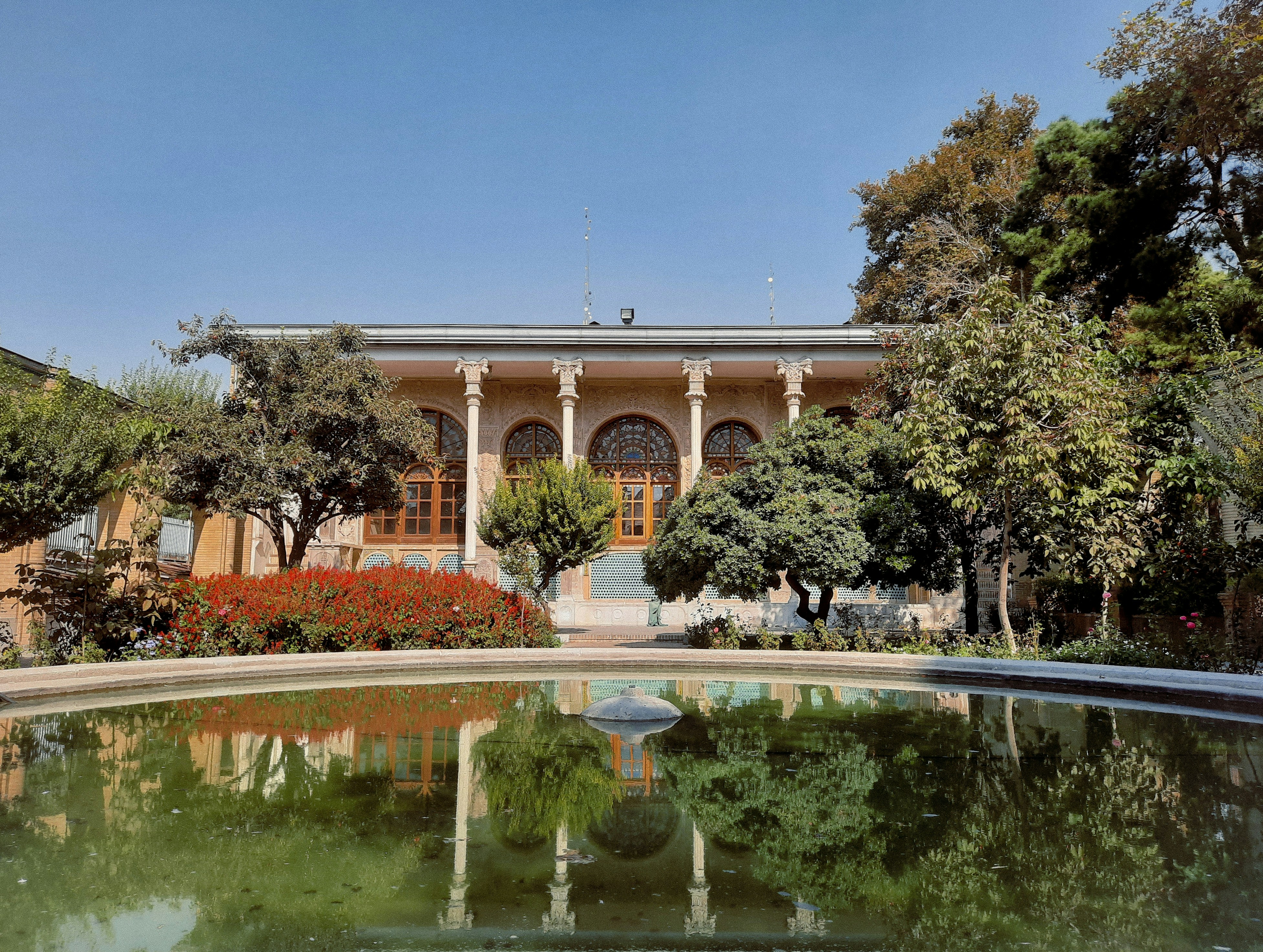 Historic building with arched windows and a reflecting pool