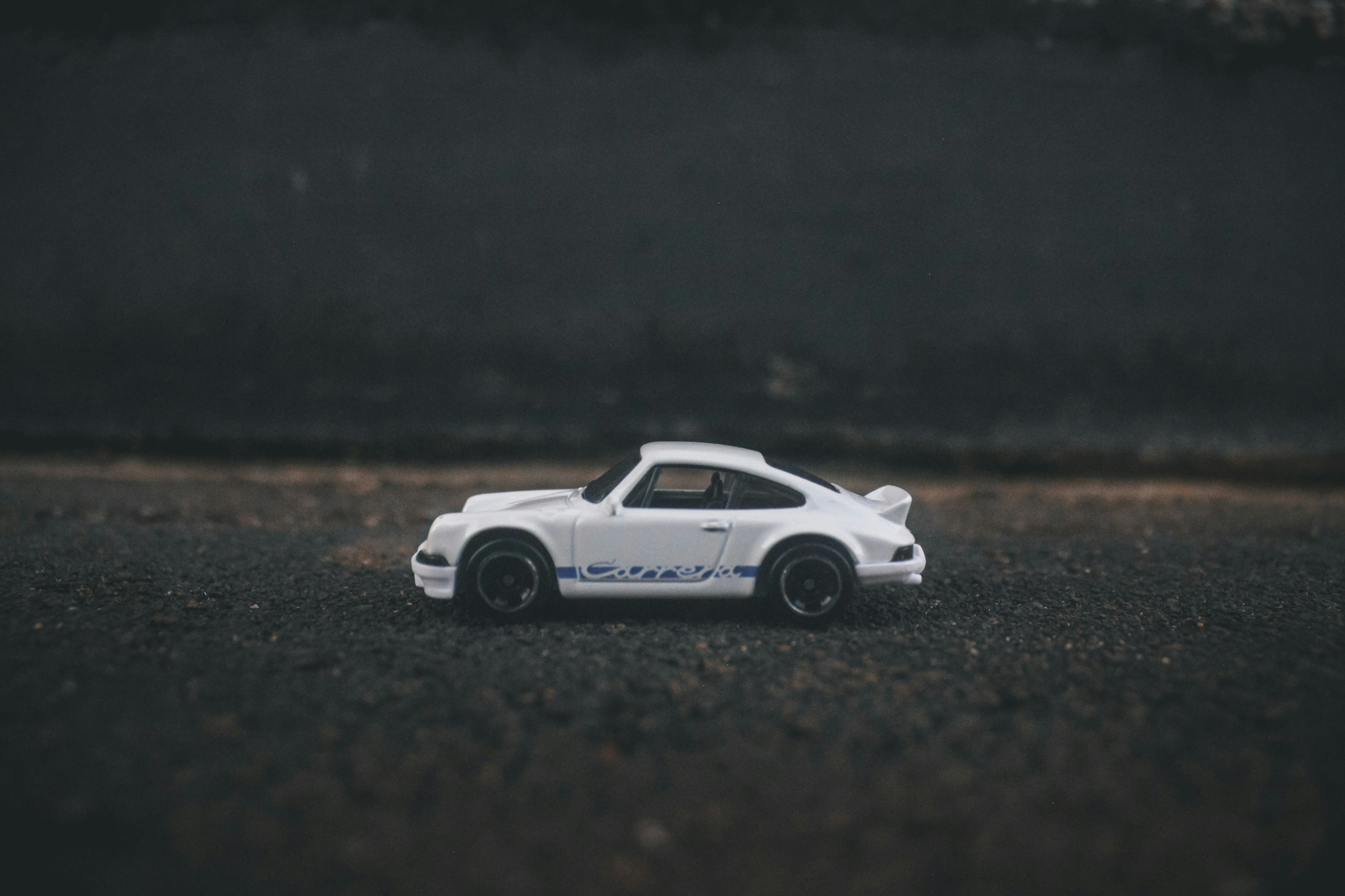 White sports car parked on a dark road