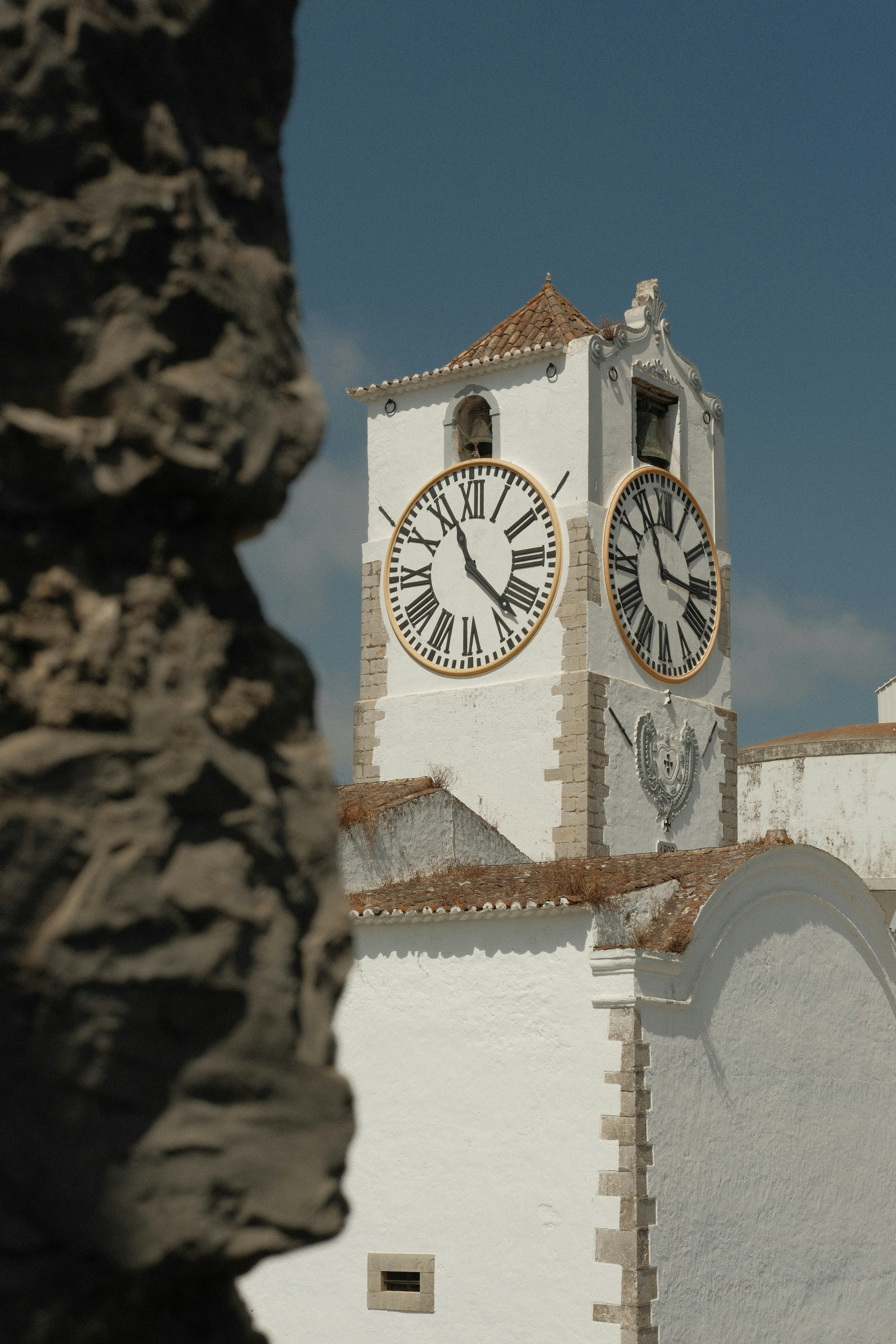 Algarve shot on Fujifilm XT-5. | White clock tower against a blue sky
