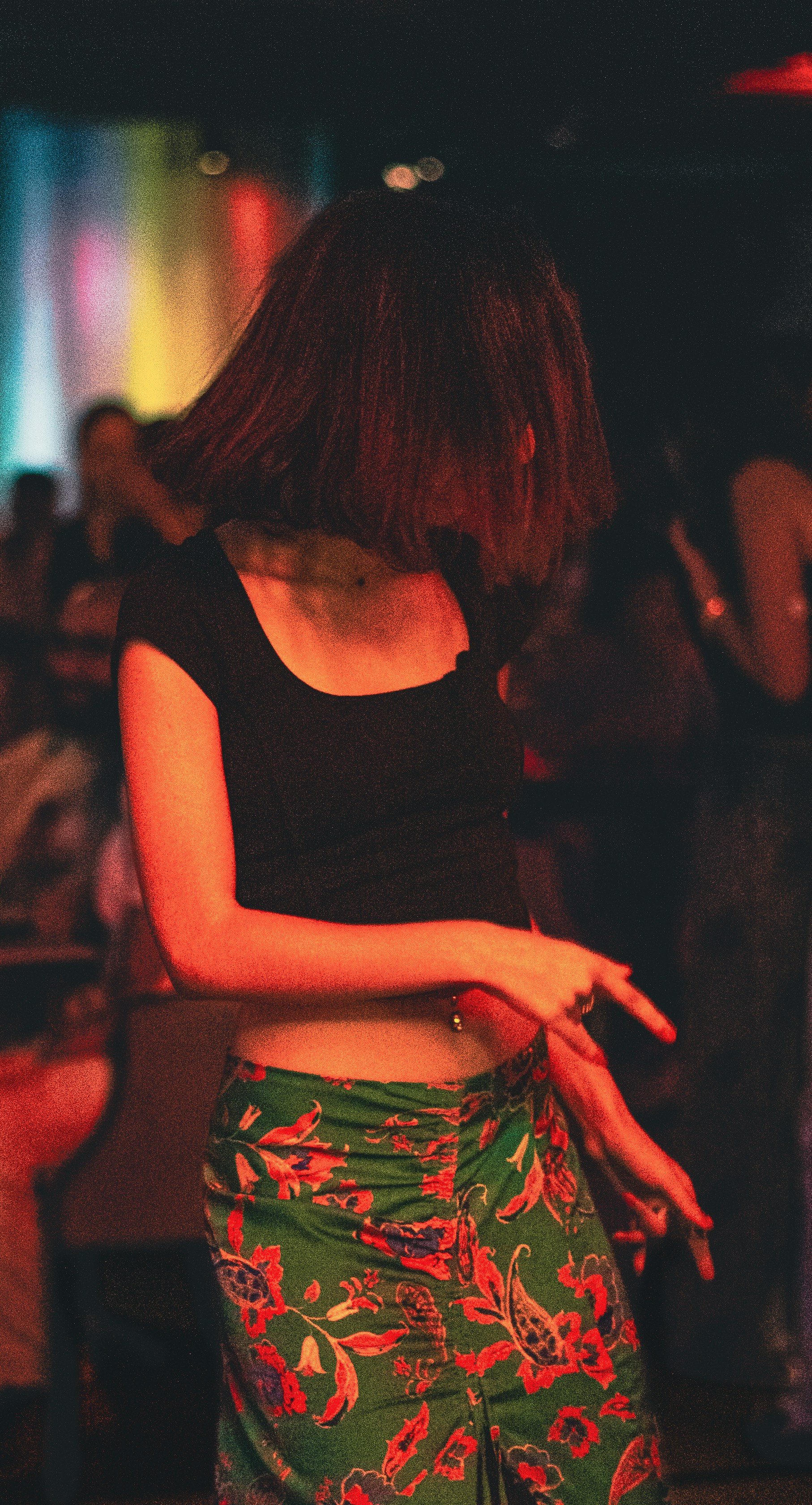 Woman dancing in a club with colorful lights