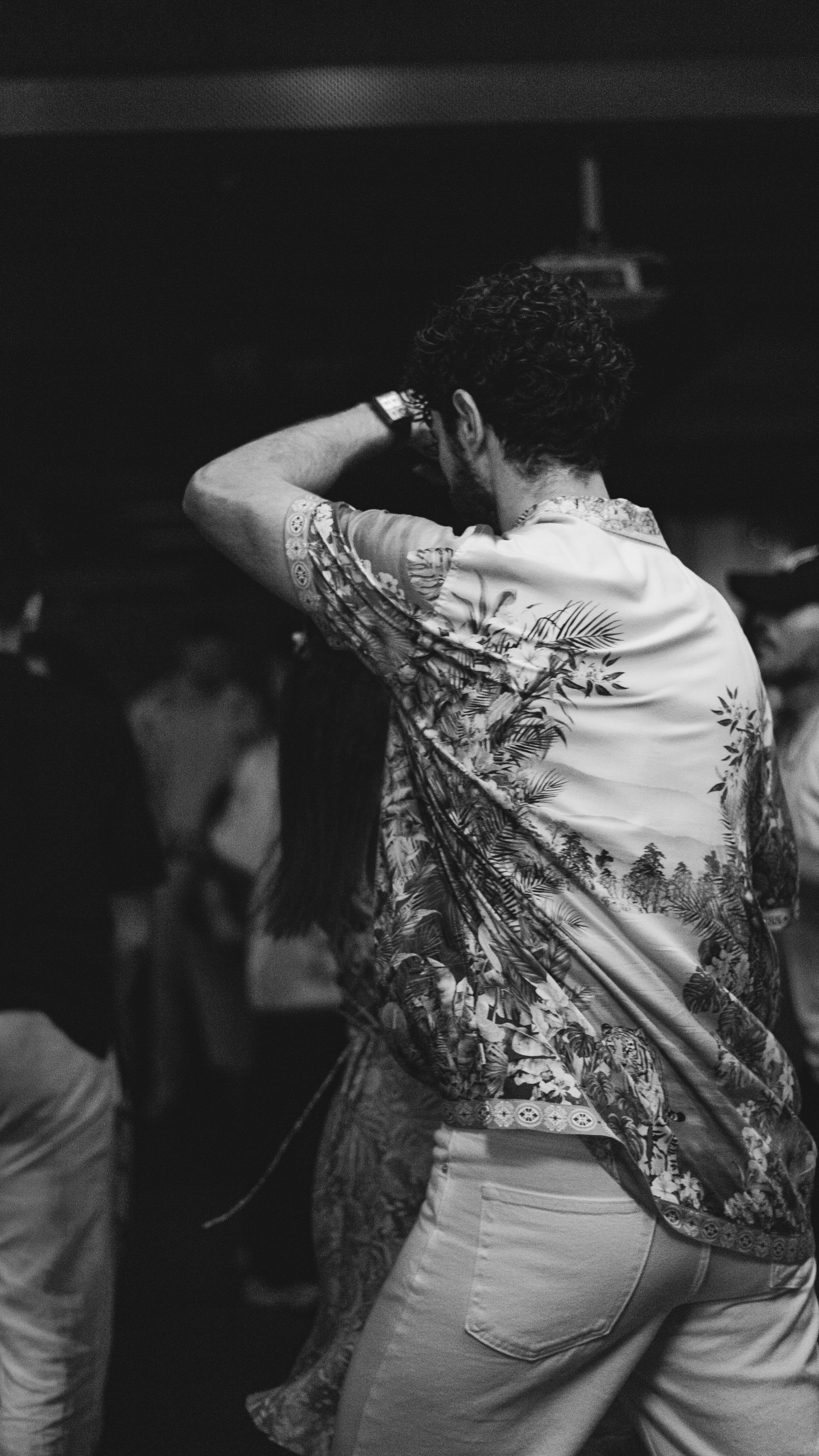 Man in patterned shirt dances with a partner